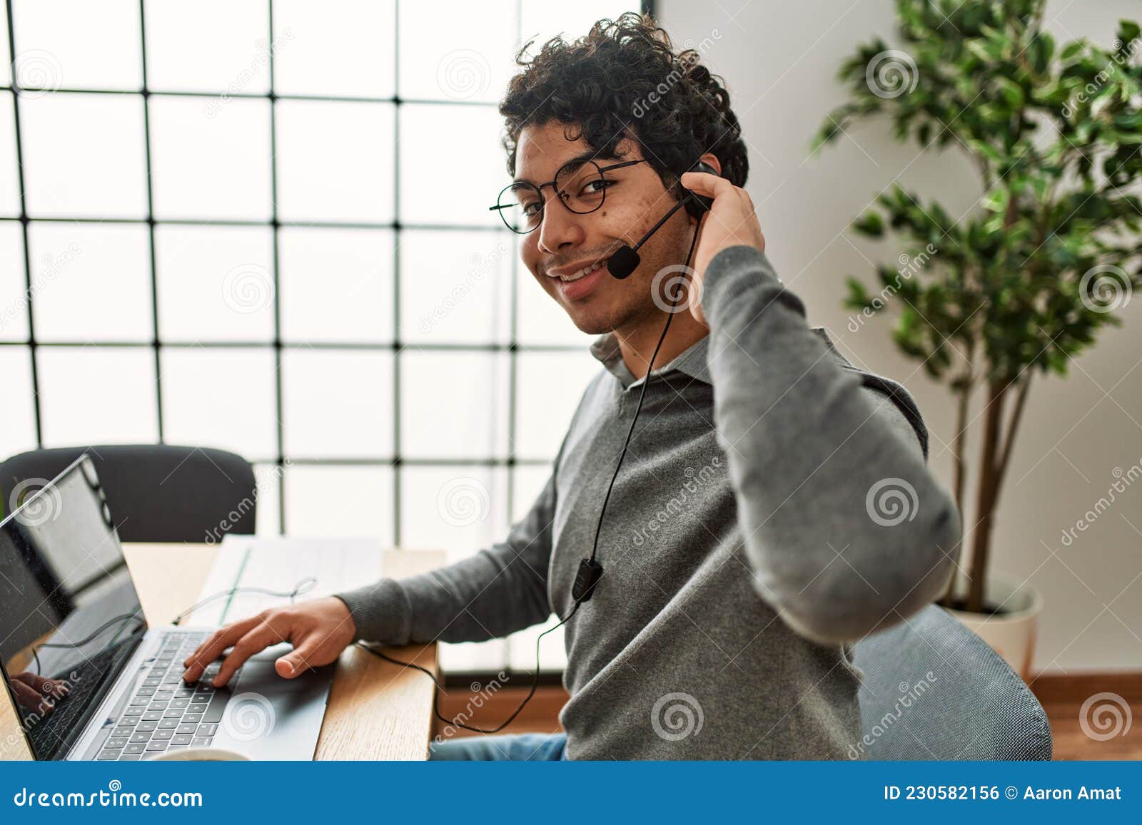 Young Hispanic Call Center Agent Man Smiling Happy Working at the ...
