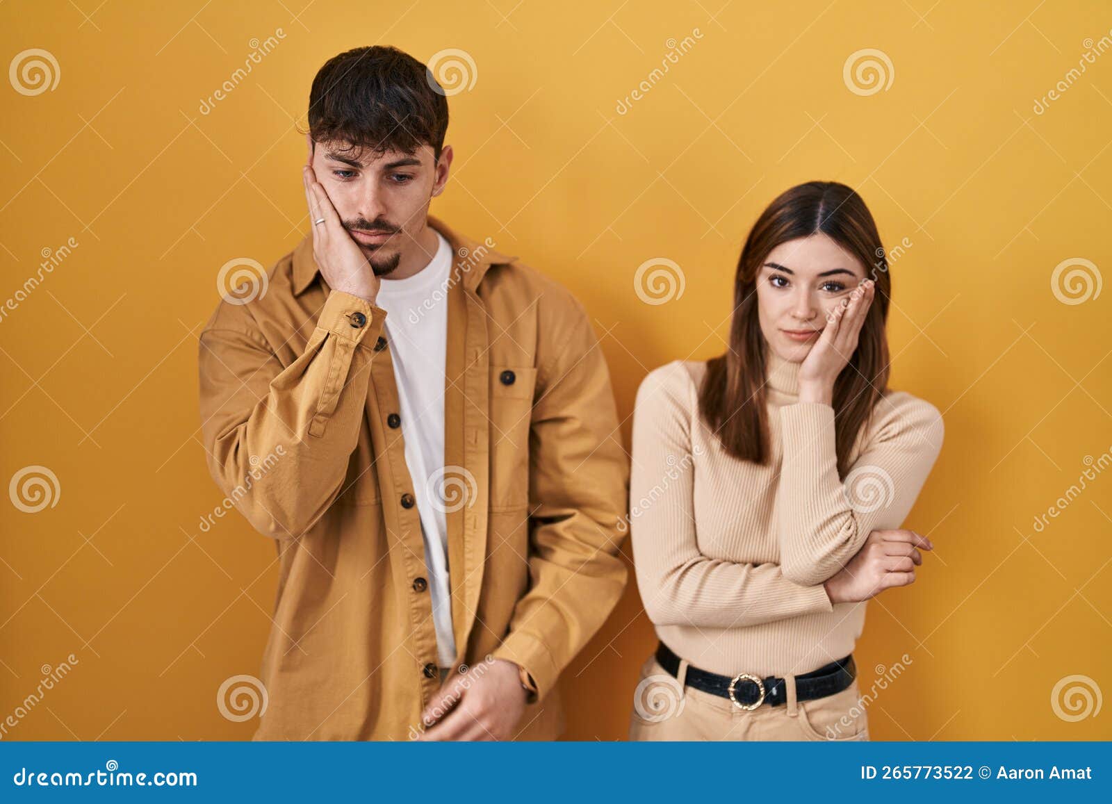 Young Hispanic Couple Standing Over Yellow Background Thinking Looking ... Young Hispanic Couple Standing Over Yellow Background Thinking Looking ...
