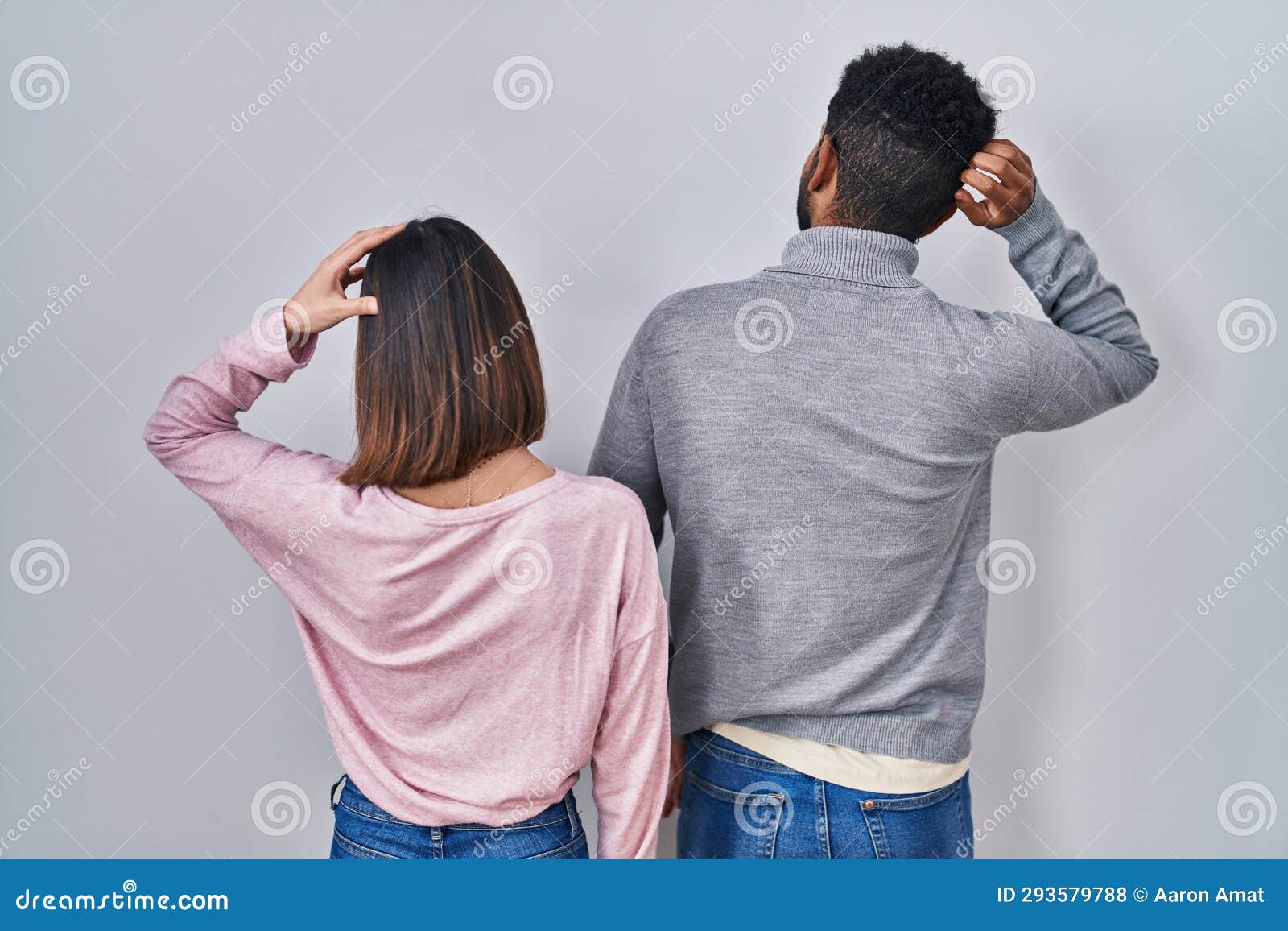 Young Hispanic Couple Standing Together Backwards Thinking about Doubt ...