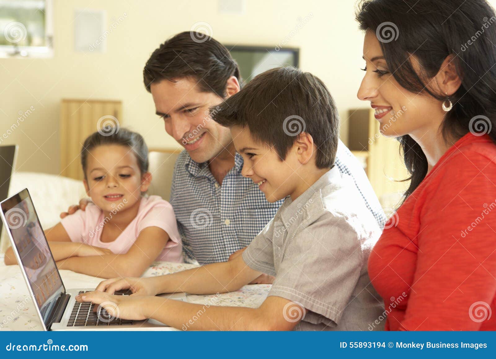 Young Hispanic Family Using Computer at Home Stock Photo - Image of ...