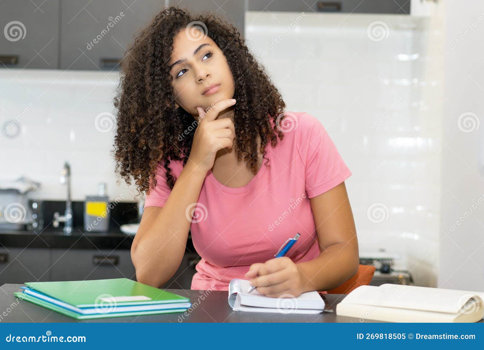 Young Hispanic Female Student Thinking about a Problem Stock Image ...