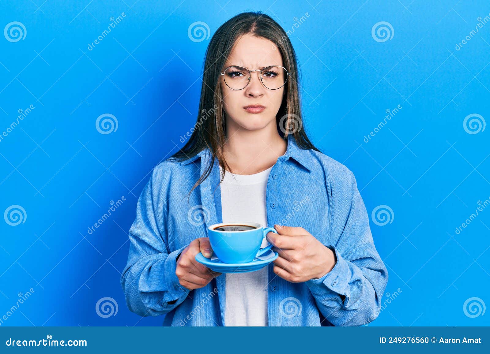 Young Hispanic Girl Drinking a Cup of Coffee Clueless and Confused ...
