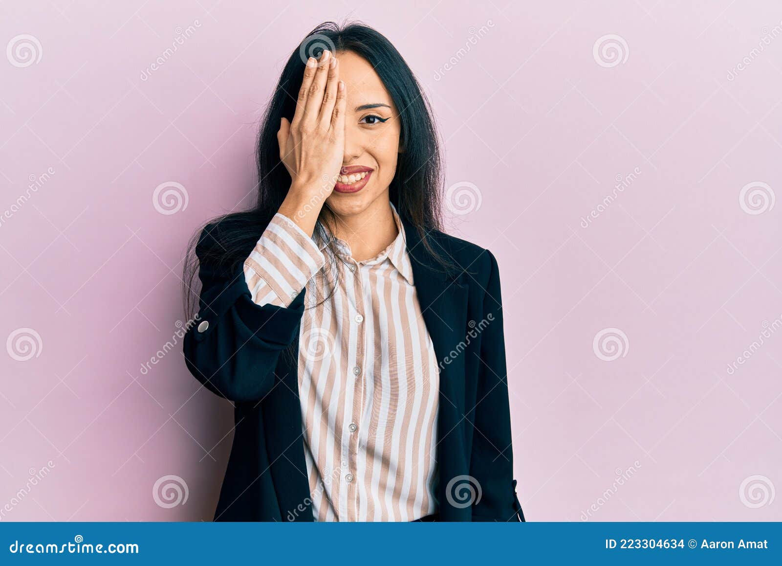 Young Hispanic Girl Wearing Business Clothes Covering One Eye With Hand