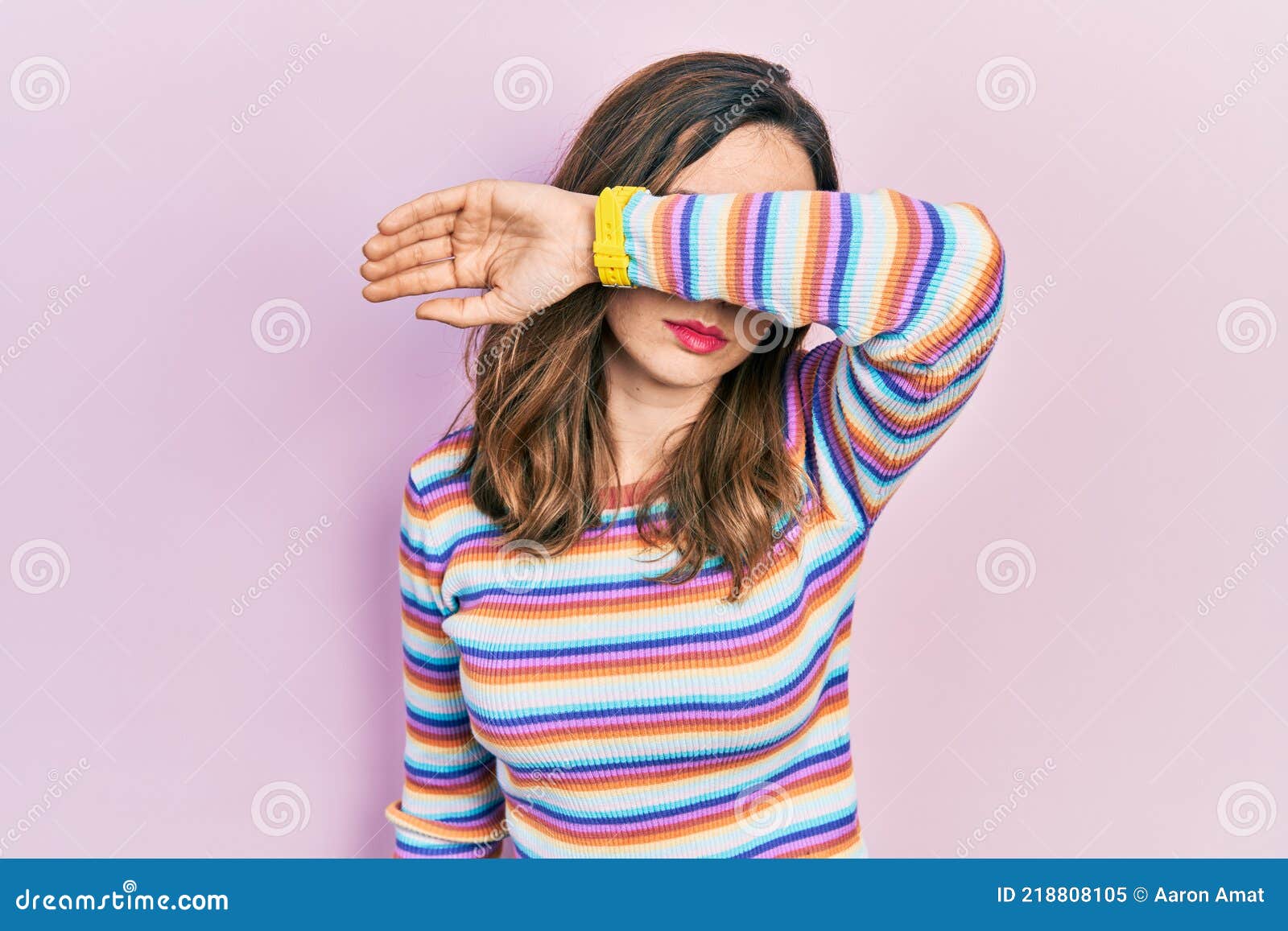 Young Hispanic Girl Wearing Casual Clothes Covering Eyes With Arm