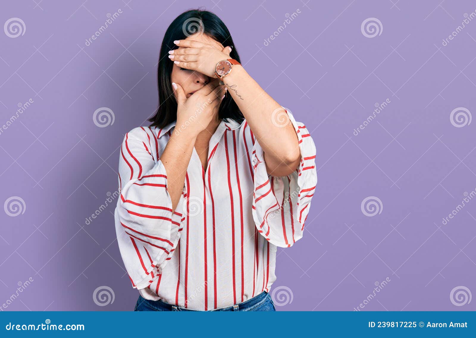 Young Hispanic Girl Wearing Casual Clothes Covering Eyes And Mouth With