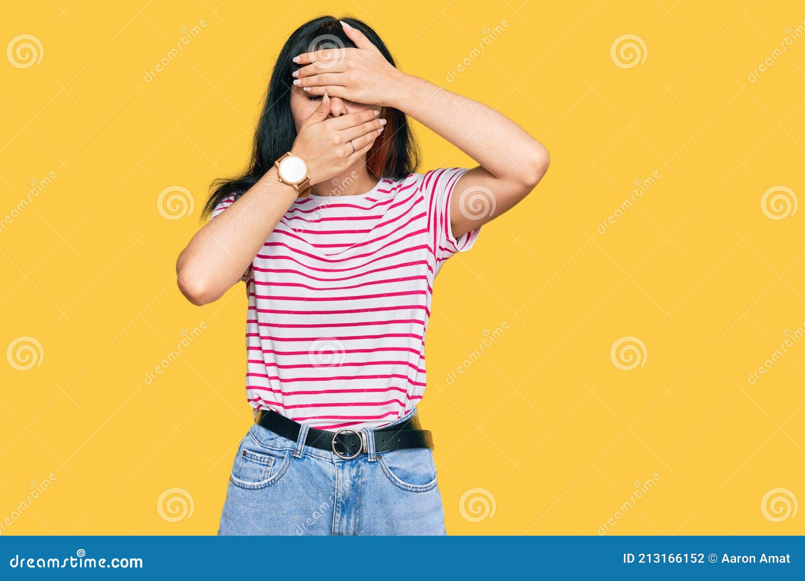 Young Hispanic Girl Wearing Casual Clothes Covering Eyes And Mouth With