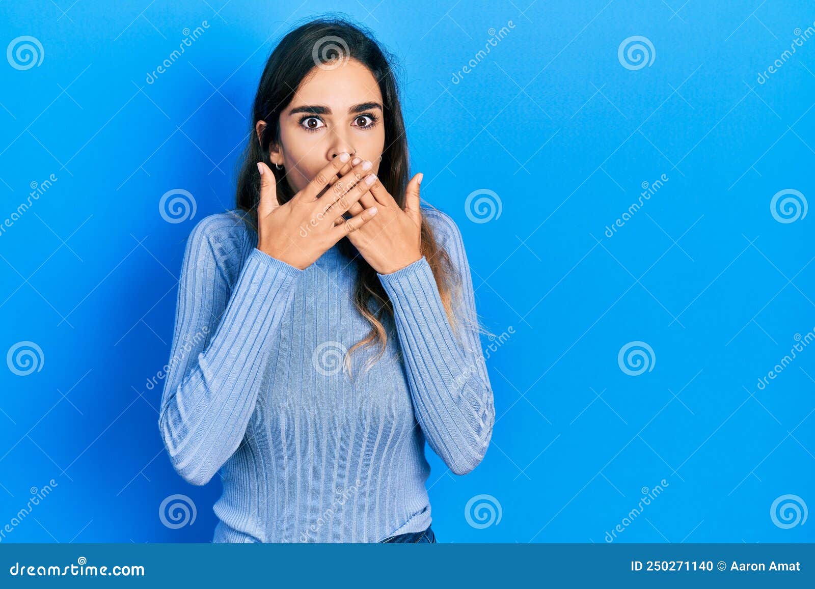 Young Hispanic Girl Wearing Casual Clothes Shocked Covering Mouth With