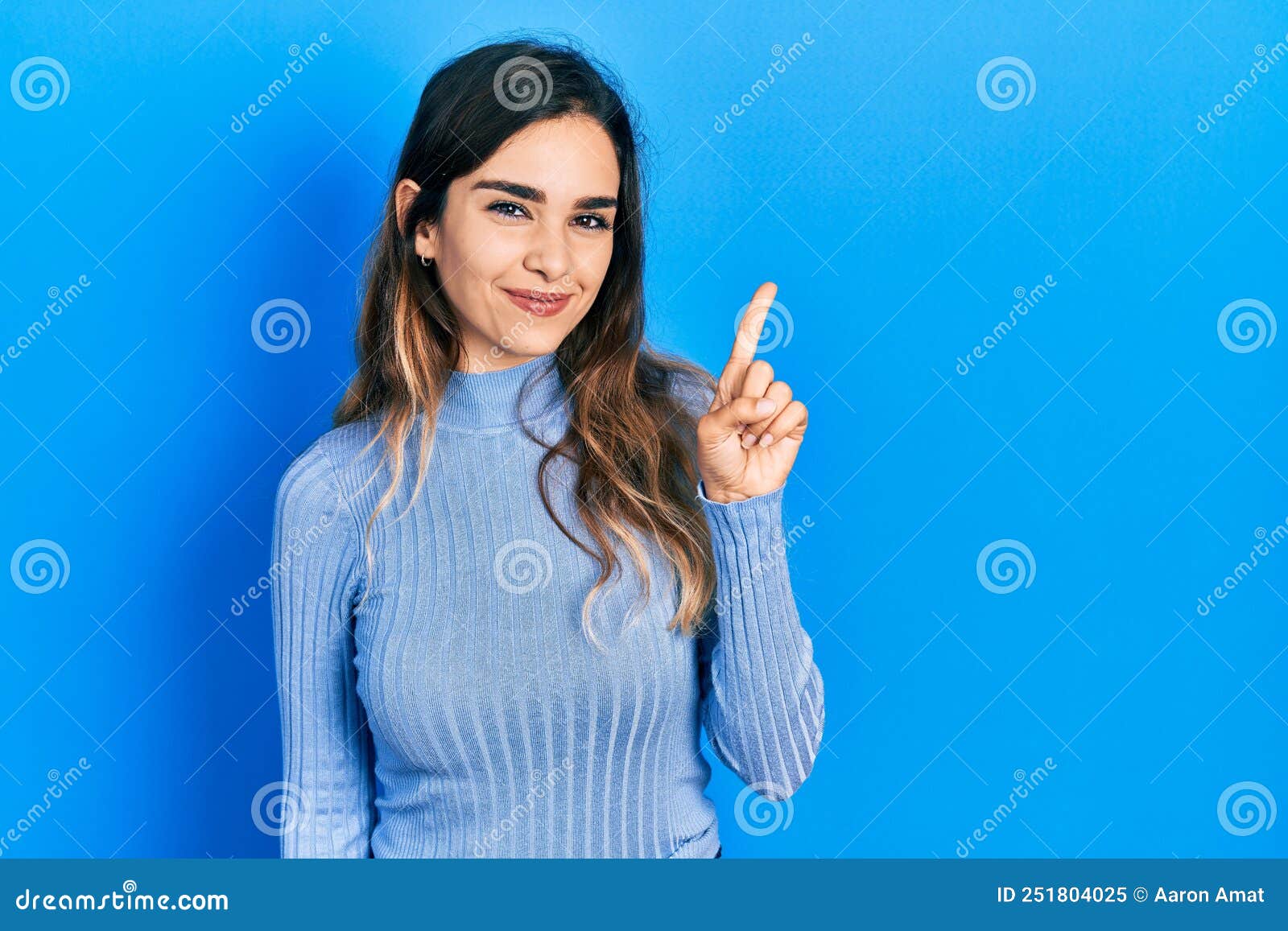 Young Hispanic Girl Wearing Casual Clothes Showing And Pointing Up With