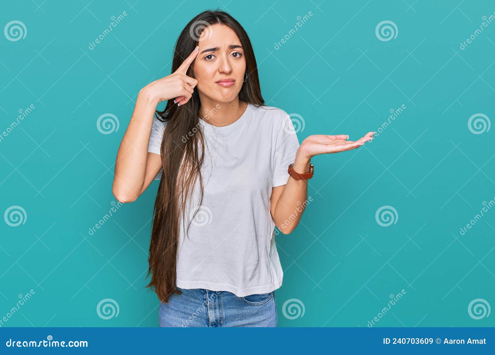 Young Hispanic Girl Wearing Casual White T Shirt Confused And Annoyed