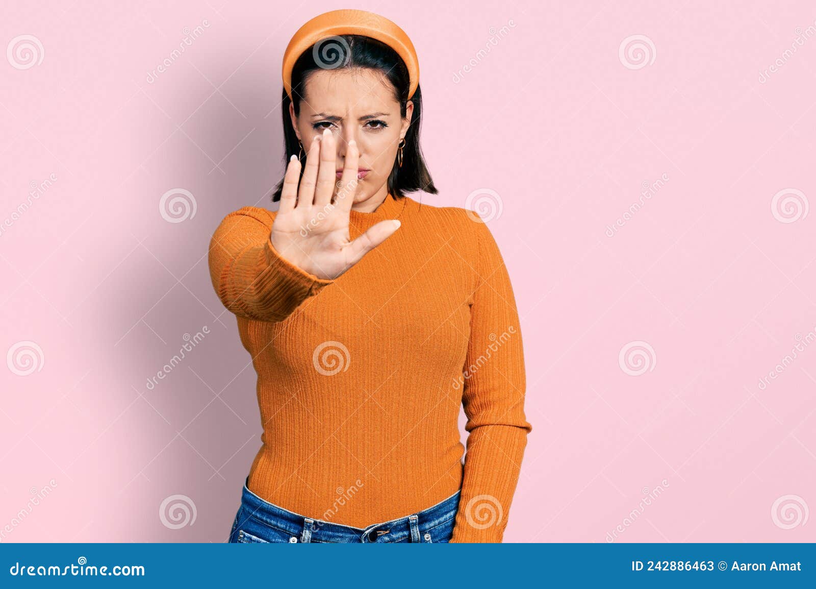 Young Hispanic Girl Wearing Casual White T Shirt Doing Stop Sing With