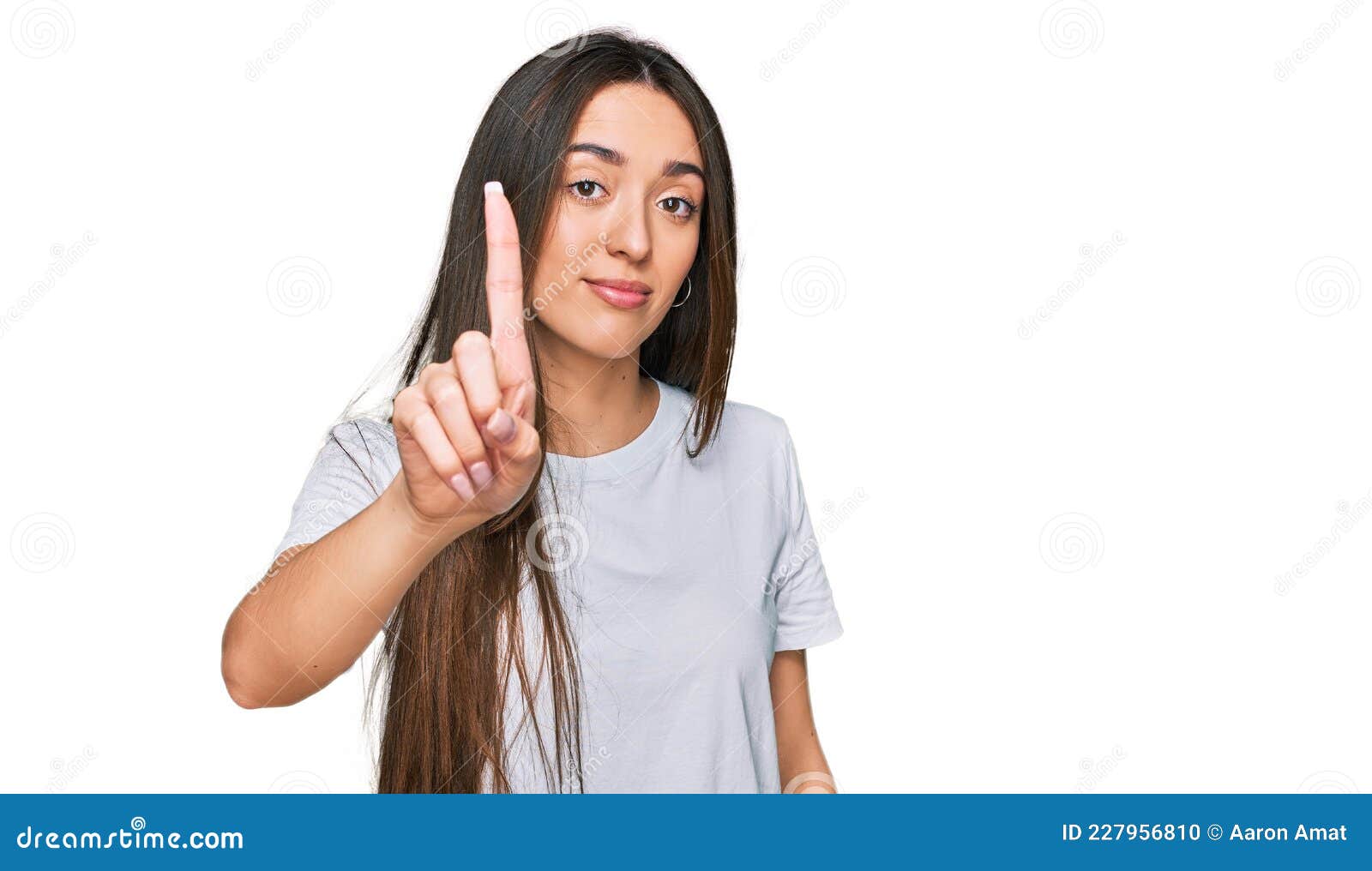 Young Hispanic Girl Wearing Casual White T Shirt Pointing With Finger