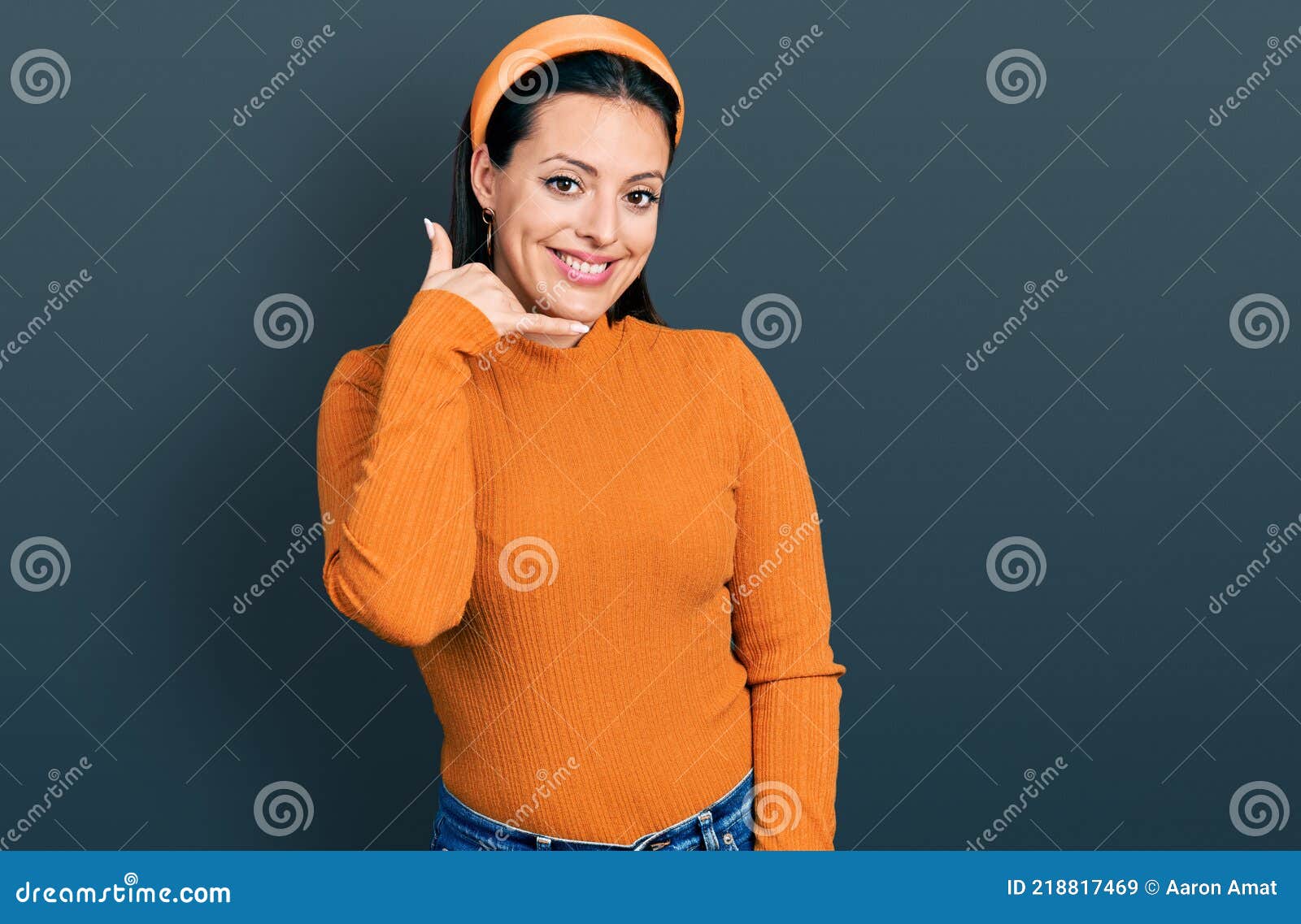 Young Hispanic Girl Wearing Casual White T Shirt Smiling Doing Phone