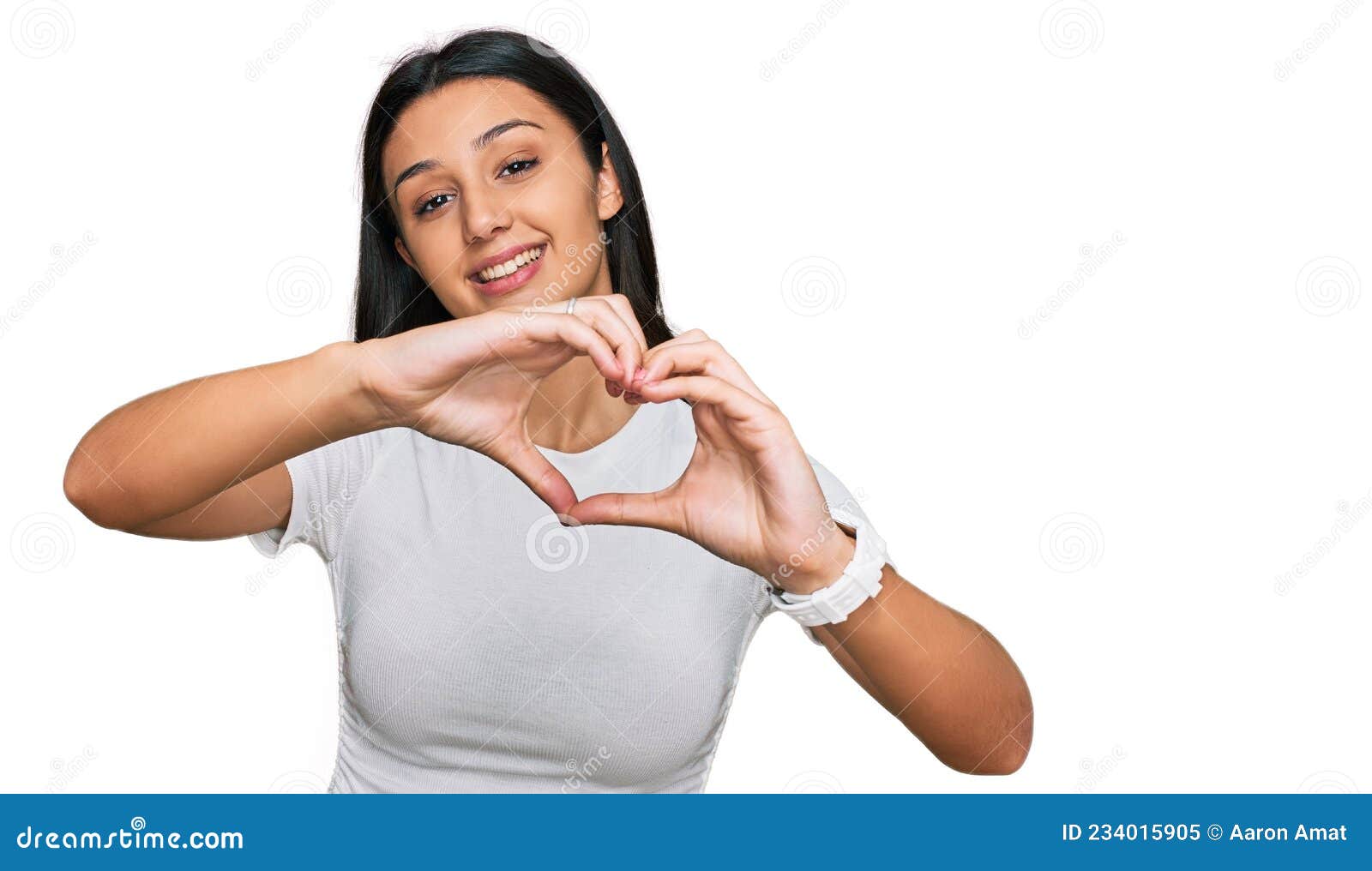 Young Hispanic Girl Wearing Casual White T Shirt Smiling In Love Doing