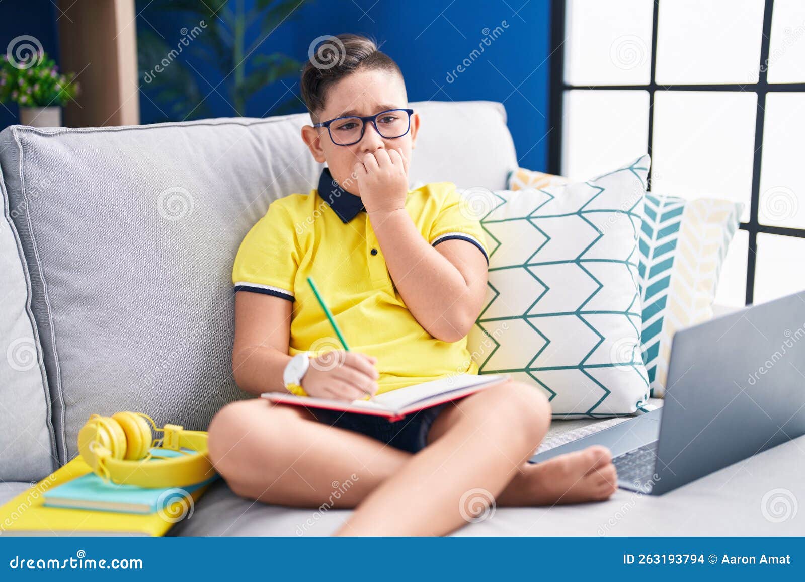 Young Hispanic Kid Doing Homework Sitting on the Sofa Looking Stressed ...