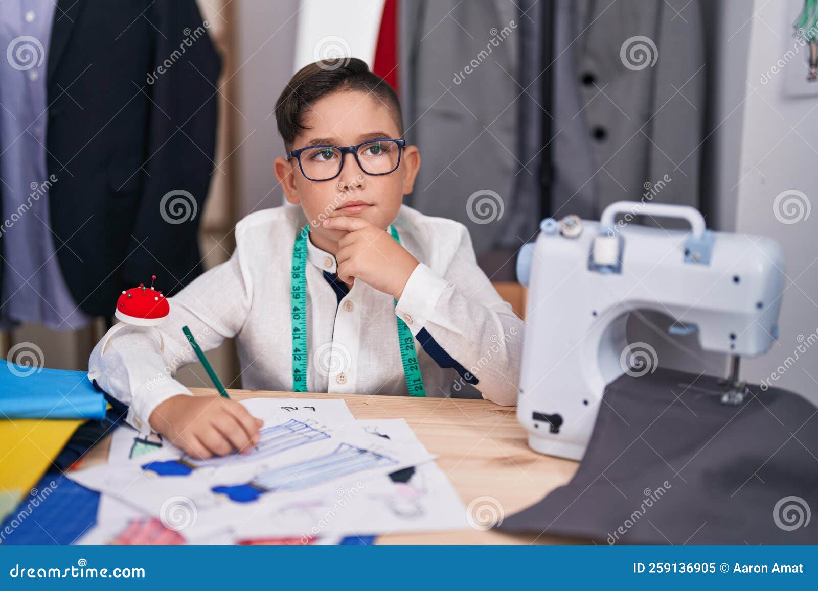 Young Hispanic Kid at Tailor Room Serious Face Thinking about Question ...