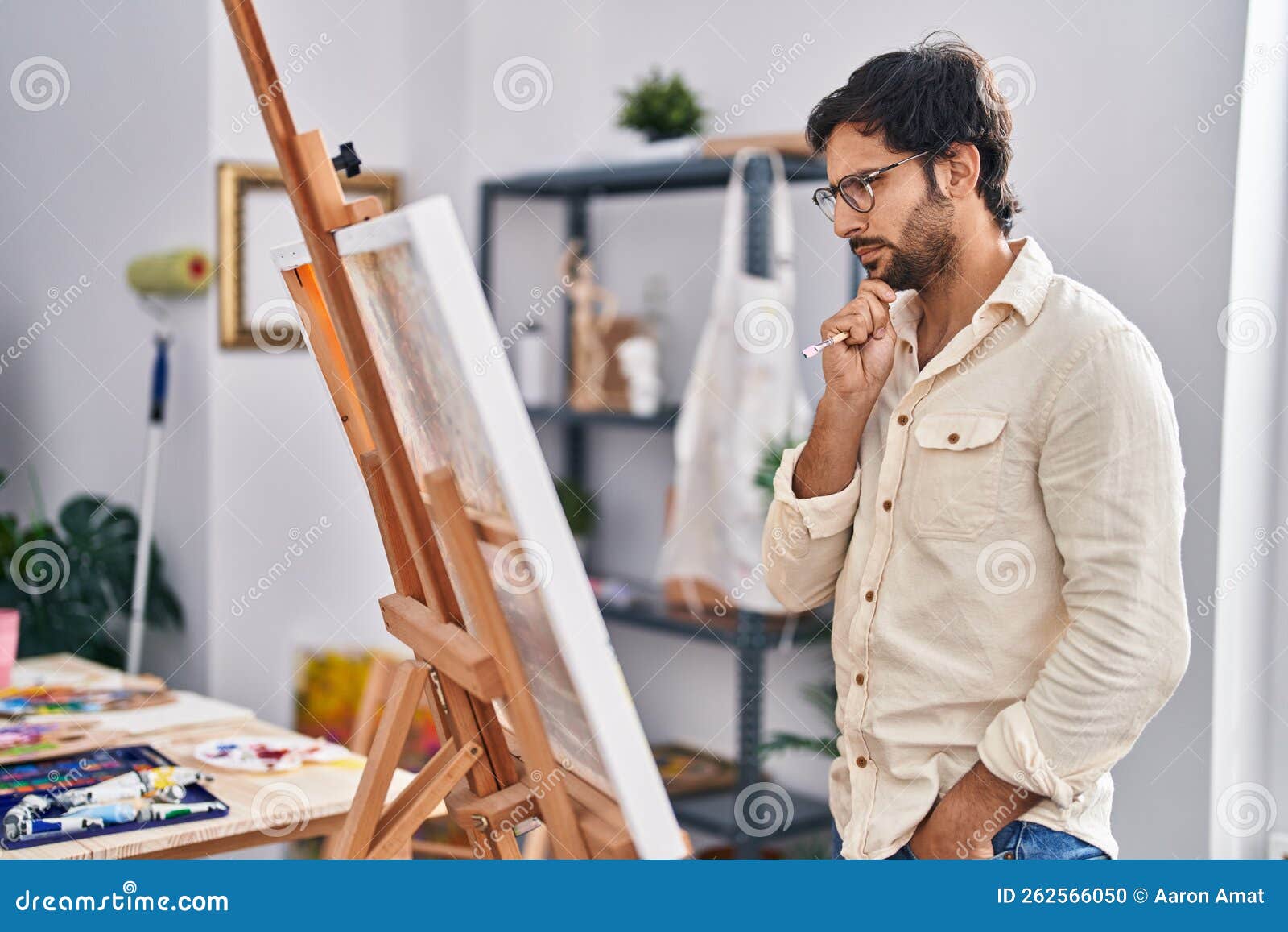 Young Hispanic Man Artist Drawing with Serious Expression at Art Studio ...