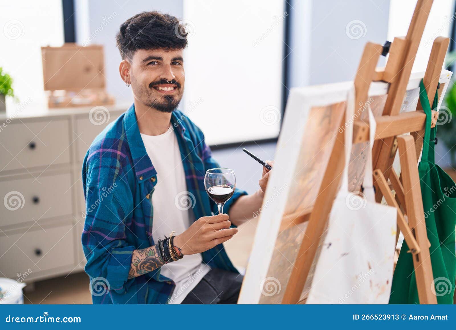 Young Hispanic Man Artist Drinking Wine Drawing at Art Studio Stock ...