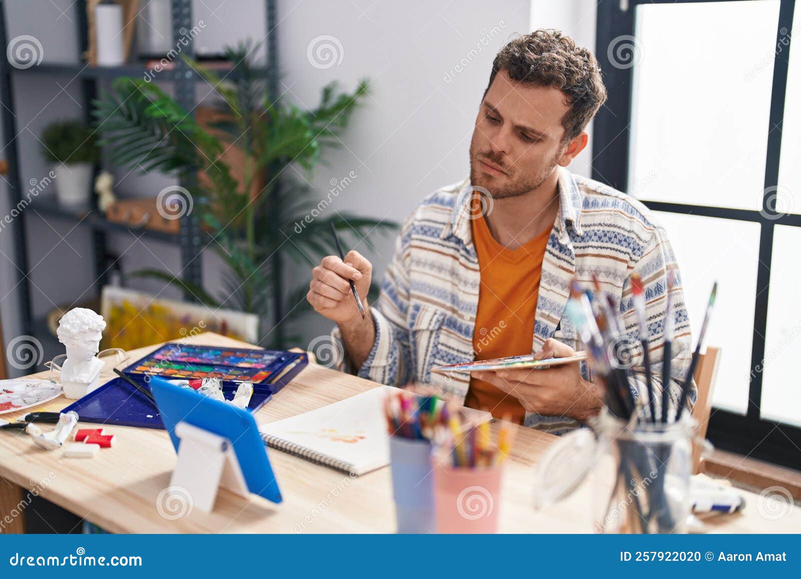 Young Hispanic Man Artist Having Video Call Drawing at Art Studio Stock ...