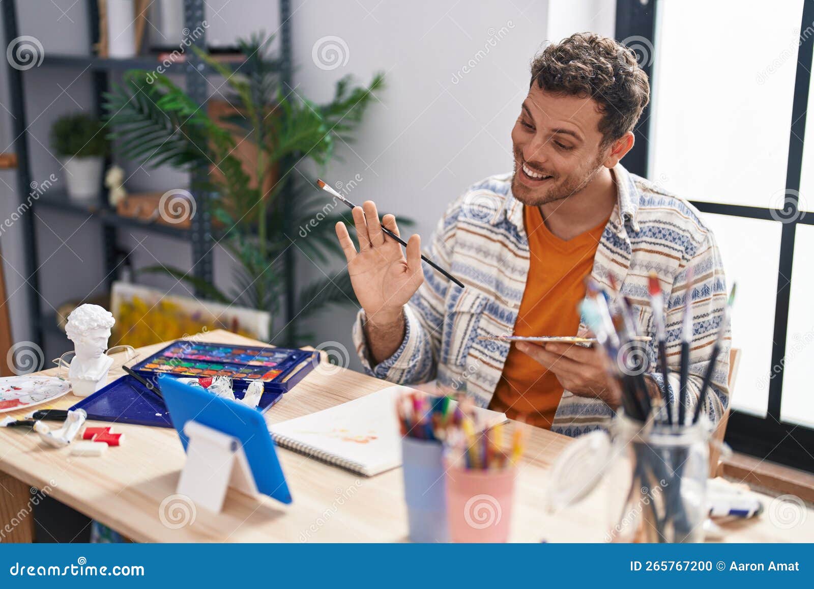 Young Hispanic Man Artist Having Video Call Drawing at Art Studio Stock ...