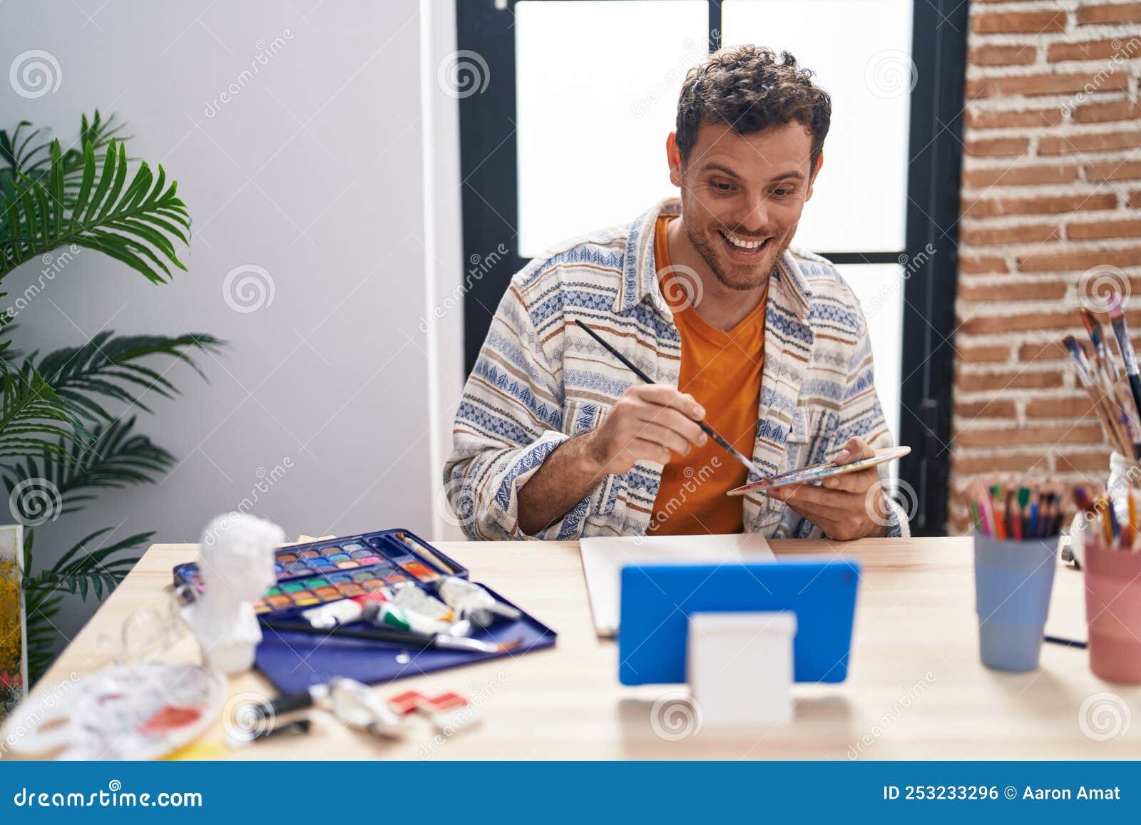 Young Hispanic Man Artist Looking Touchpad Drawing at Art Studio Stock ...