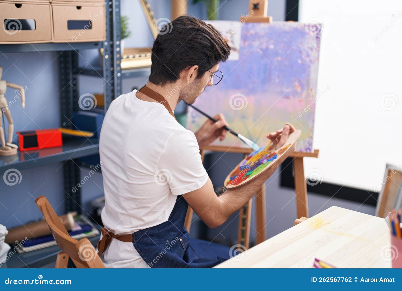 Young Hispanic Man Artist Sitting on Back View Drawing at Art Studio ...