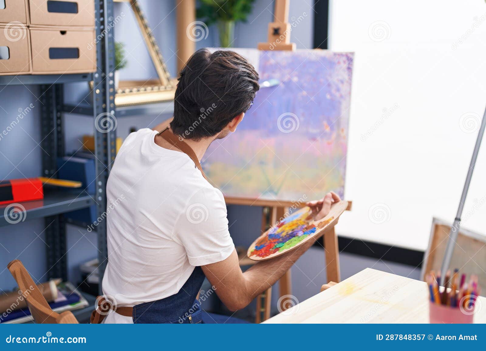 Young Hispanic Man Artist Sitting on Back View Drawing at Art Studio ...