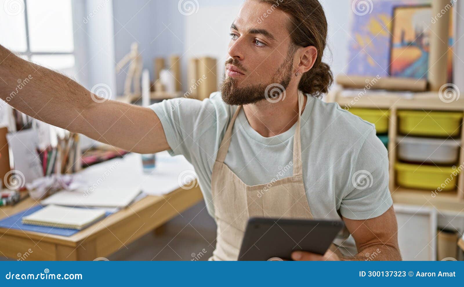 Young Hispanic Man Artist Using Touchpad Drawing at Art Studio Stock ...