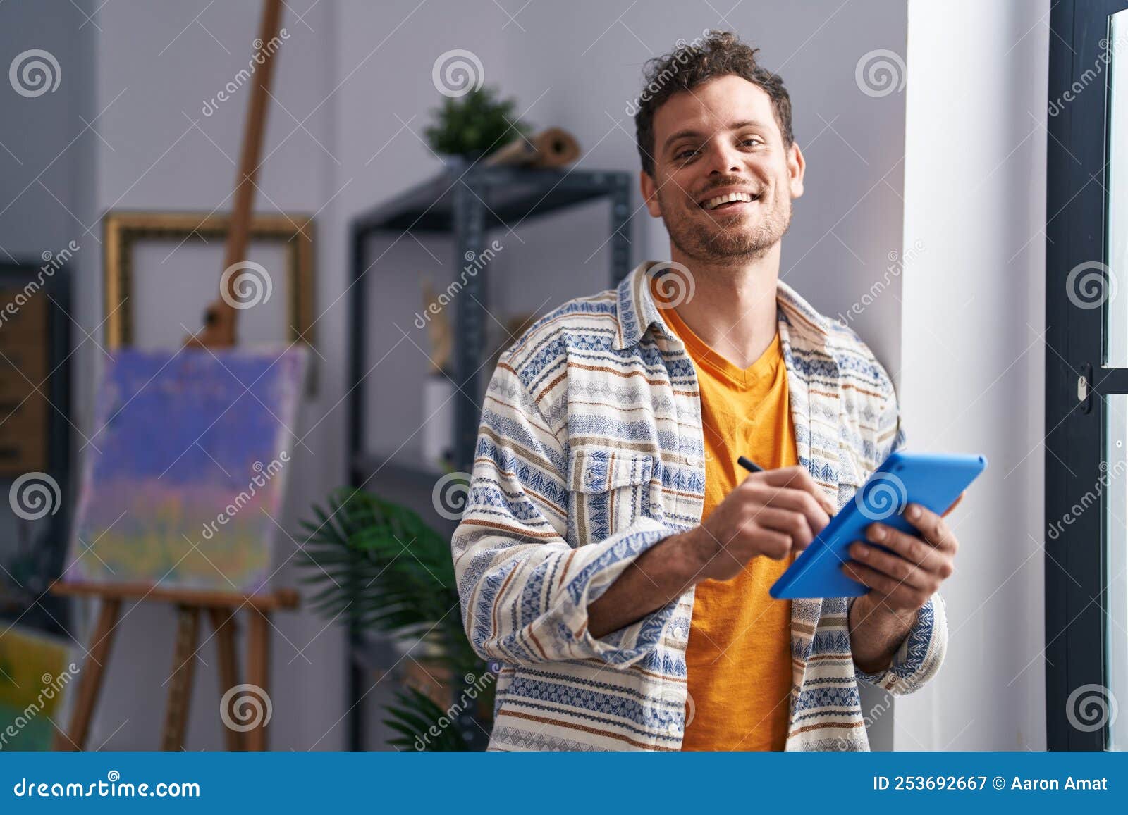 Young Hispanic Man Artist Using Touchpad Standing at Art Studio Stock ...