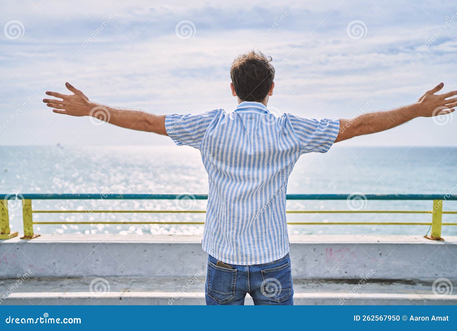 Young Hispanic Man on Back View Breathing with Arms Open at the ...