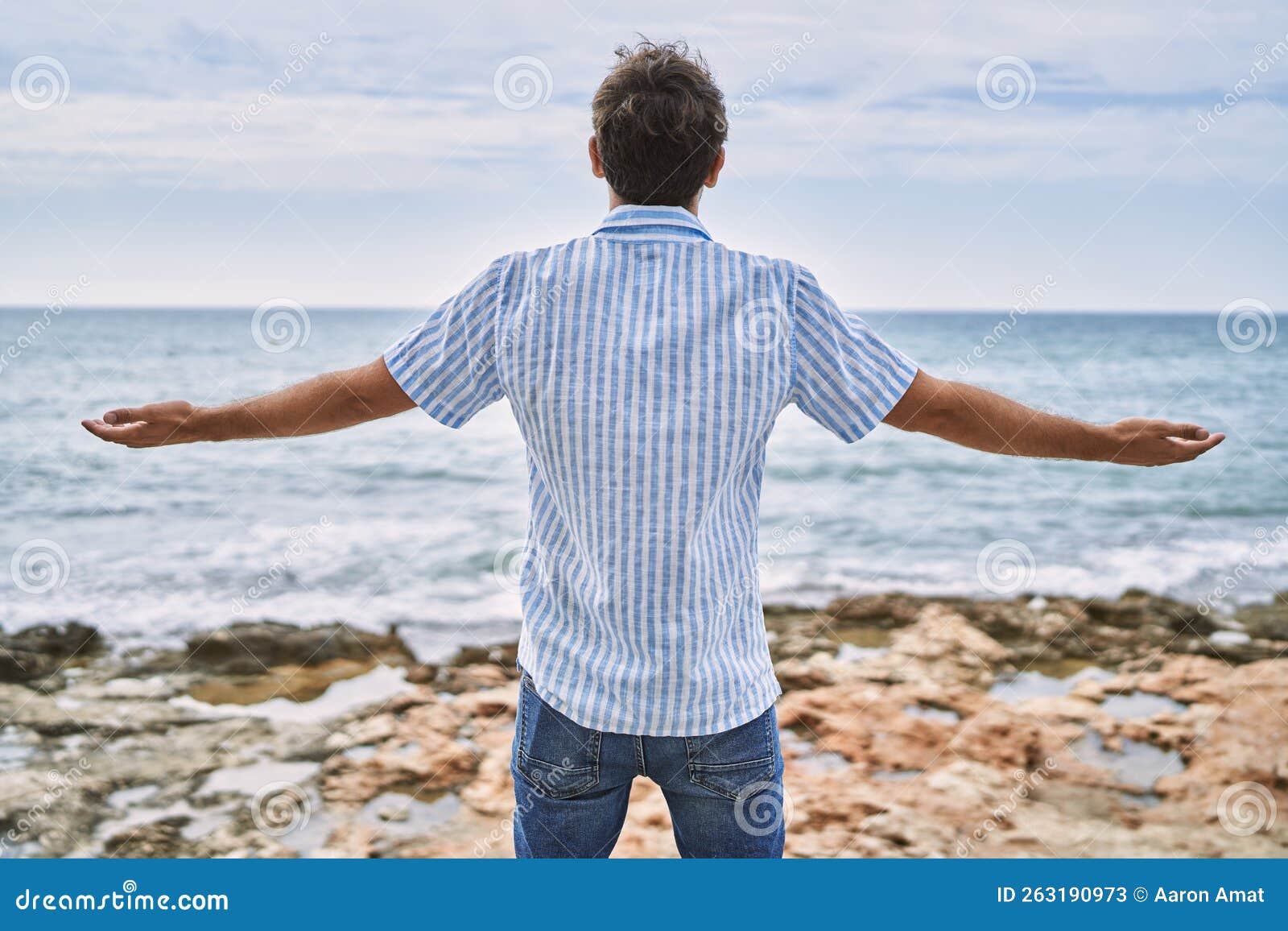 Young Hispanic Man on Back View Standing with Open Arms at the Beach ...
