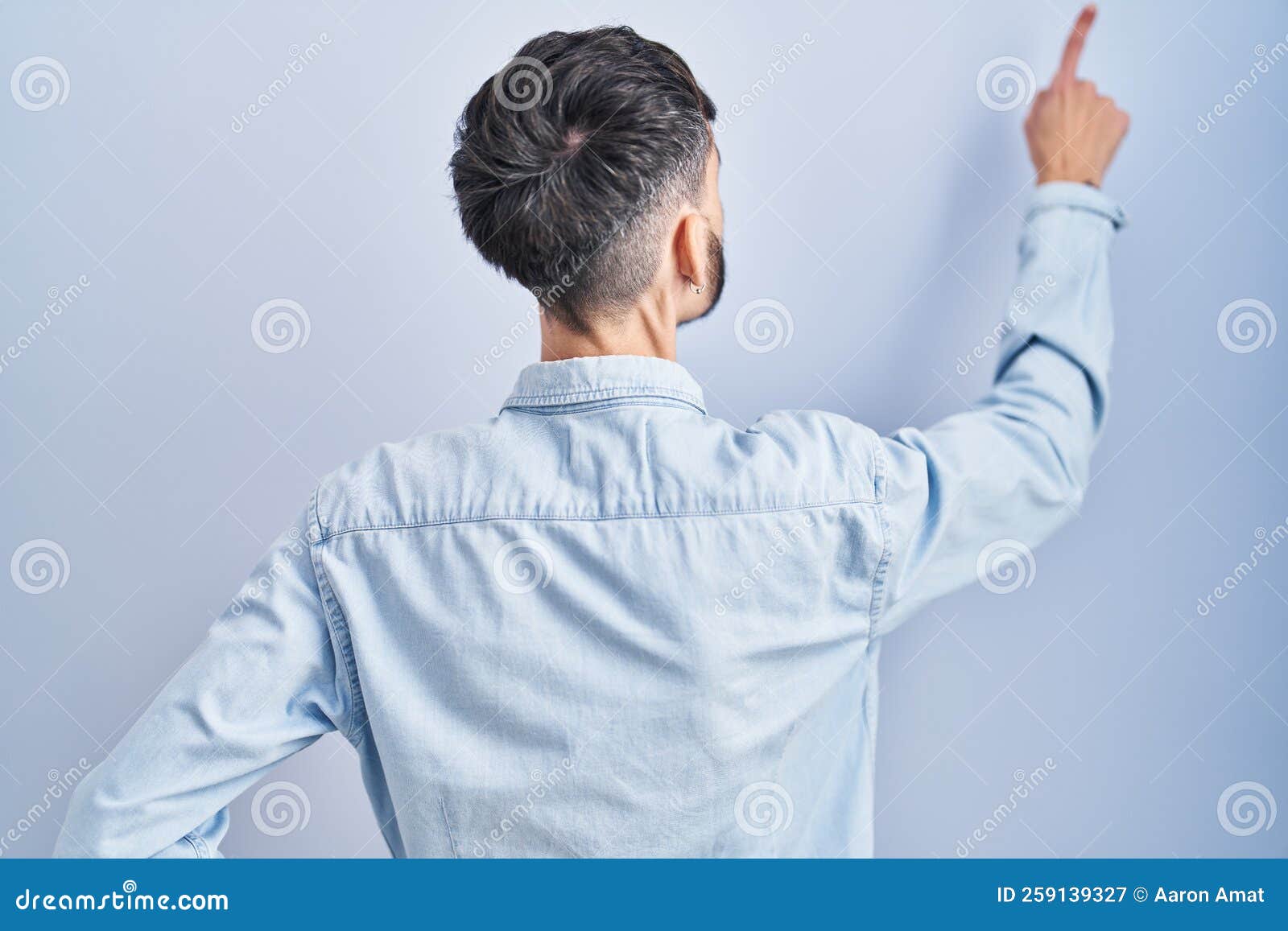 Young Hispanic Man with Beard Standing Over Blue Background Posing ...