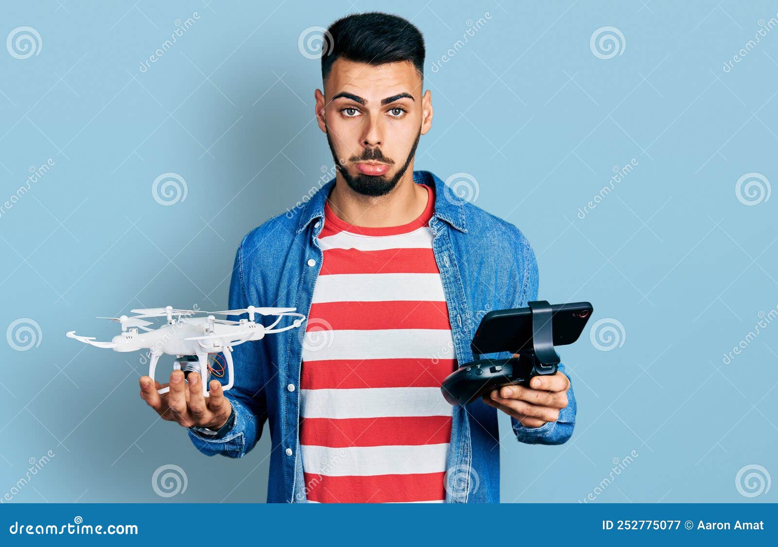 Young Hispanic Man with Beard Using Drone with Remote Control Depressed ...