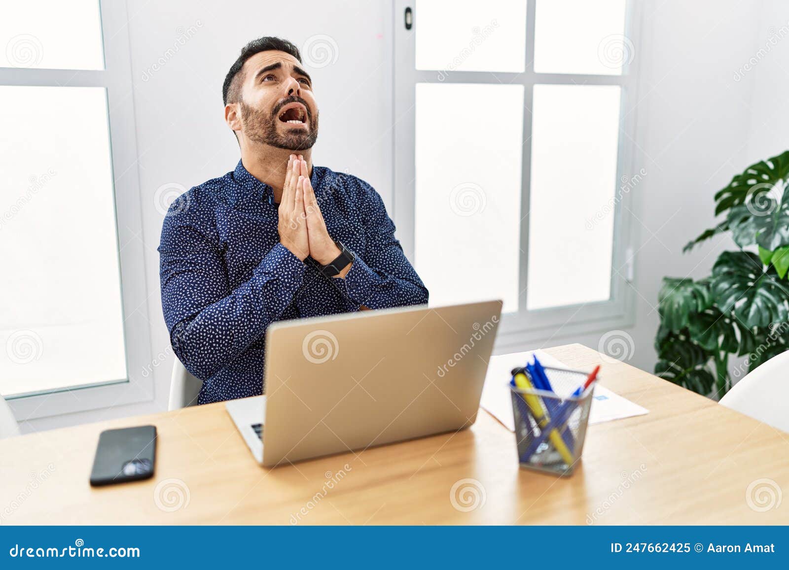 Young Hispanic Man with Beard Working at the Office with Laptop Begging ...