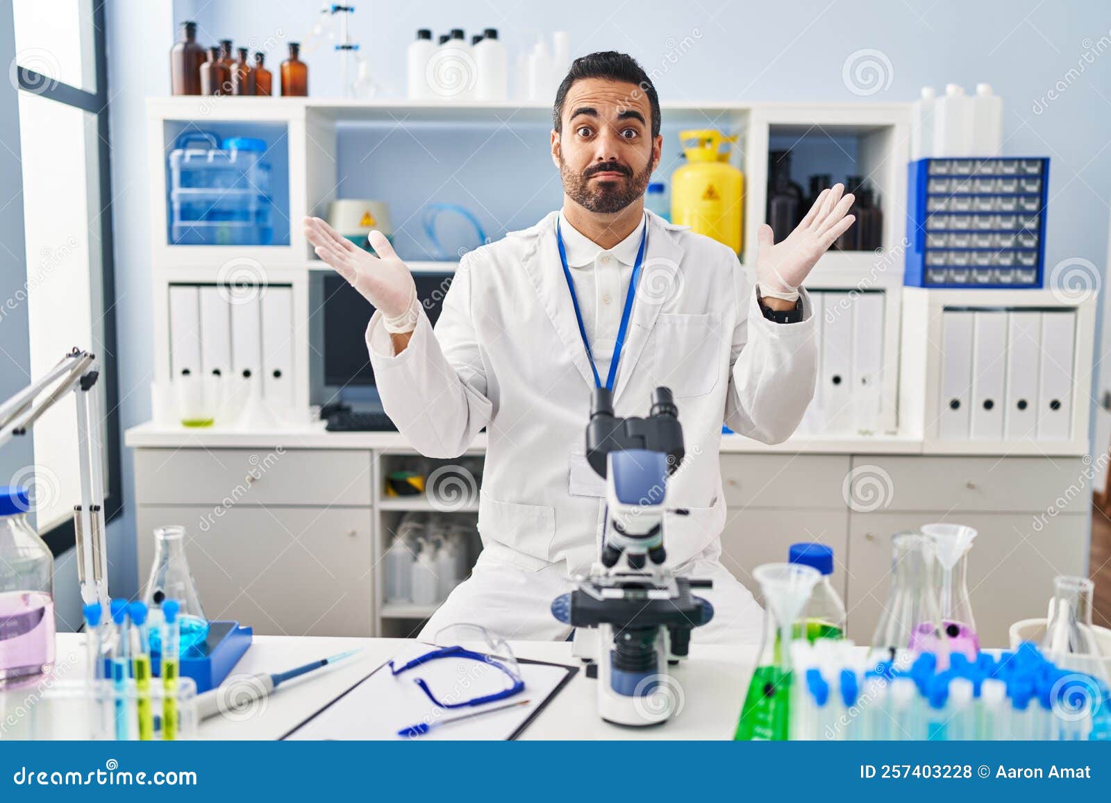 Young Hispanic Man with Beard Working at Scientist Laboratory Clueless ...