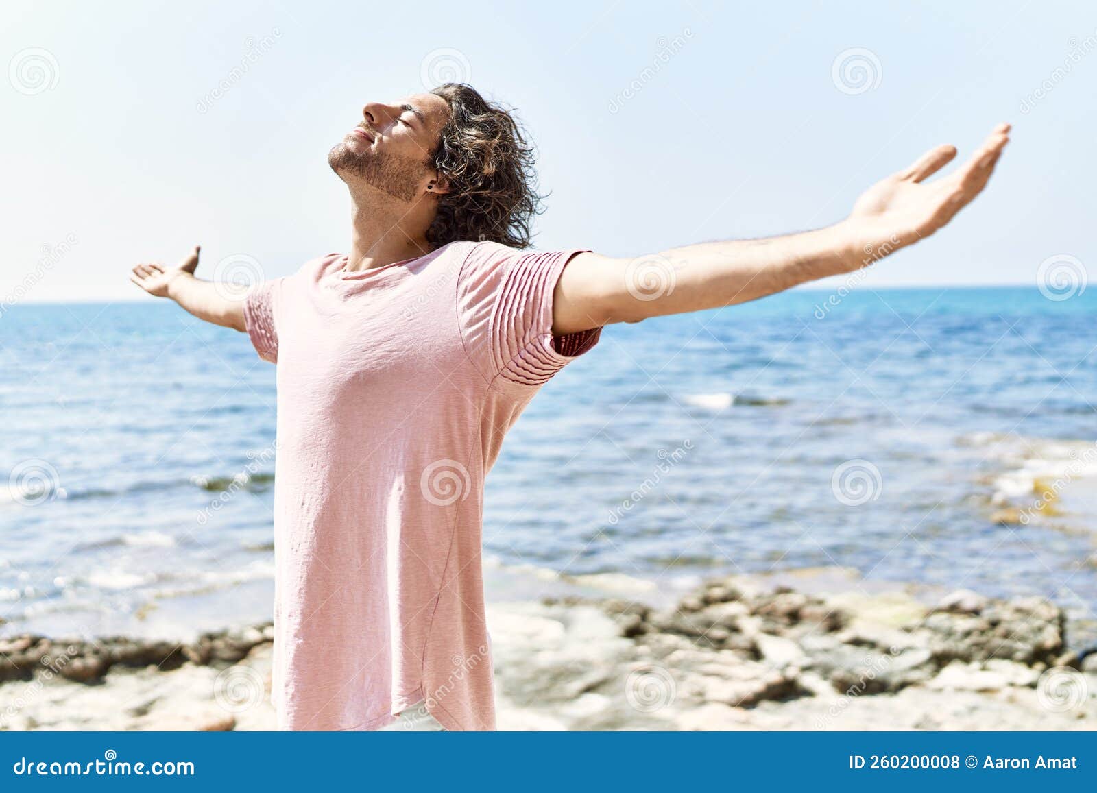 Young Hispanic Man Breathing Standing with Arms Open at the Beach Stock ...