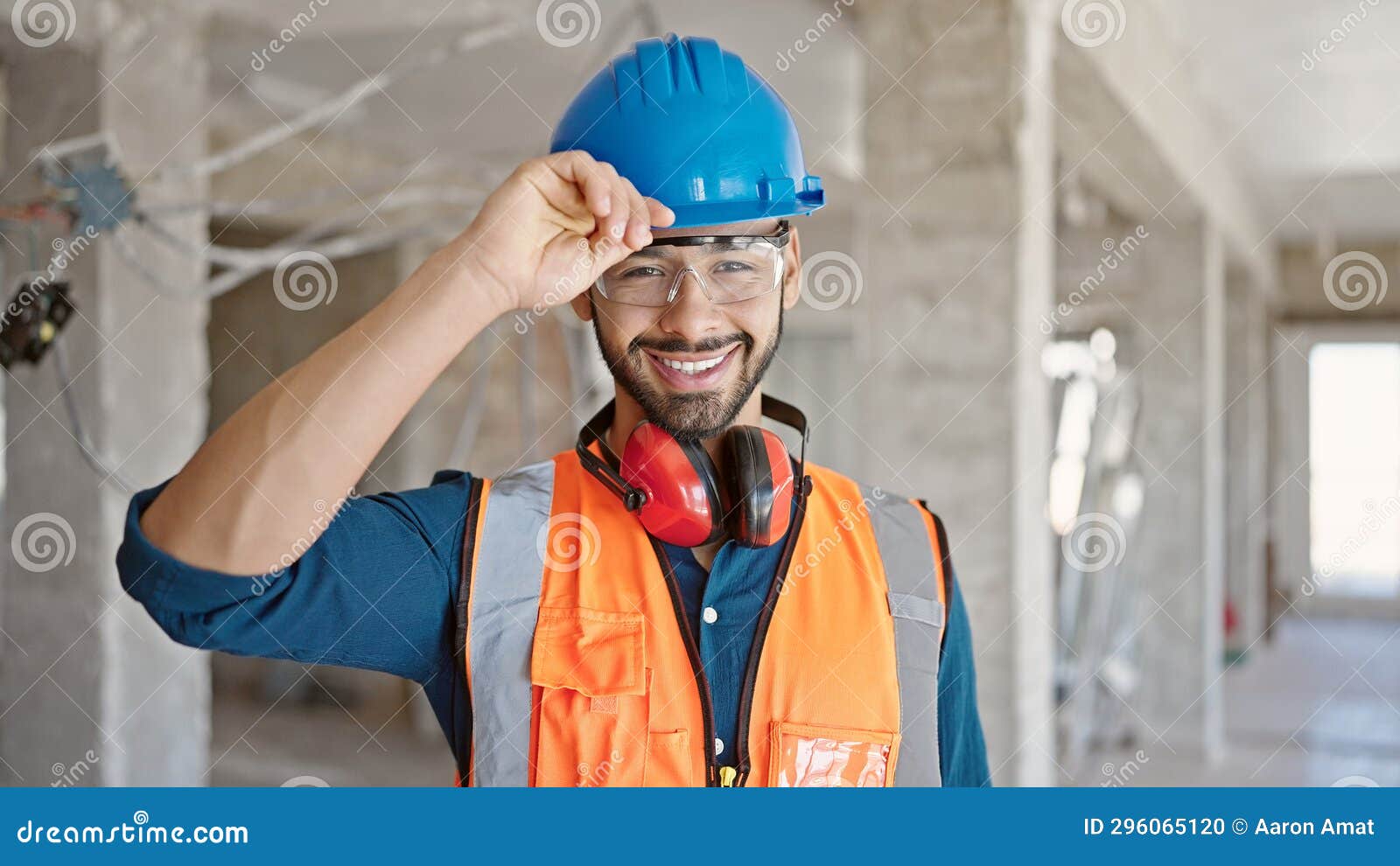 Young Hispanic Man Builder Smiling Confident Wearing Hardhat Greeting ...