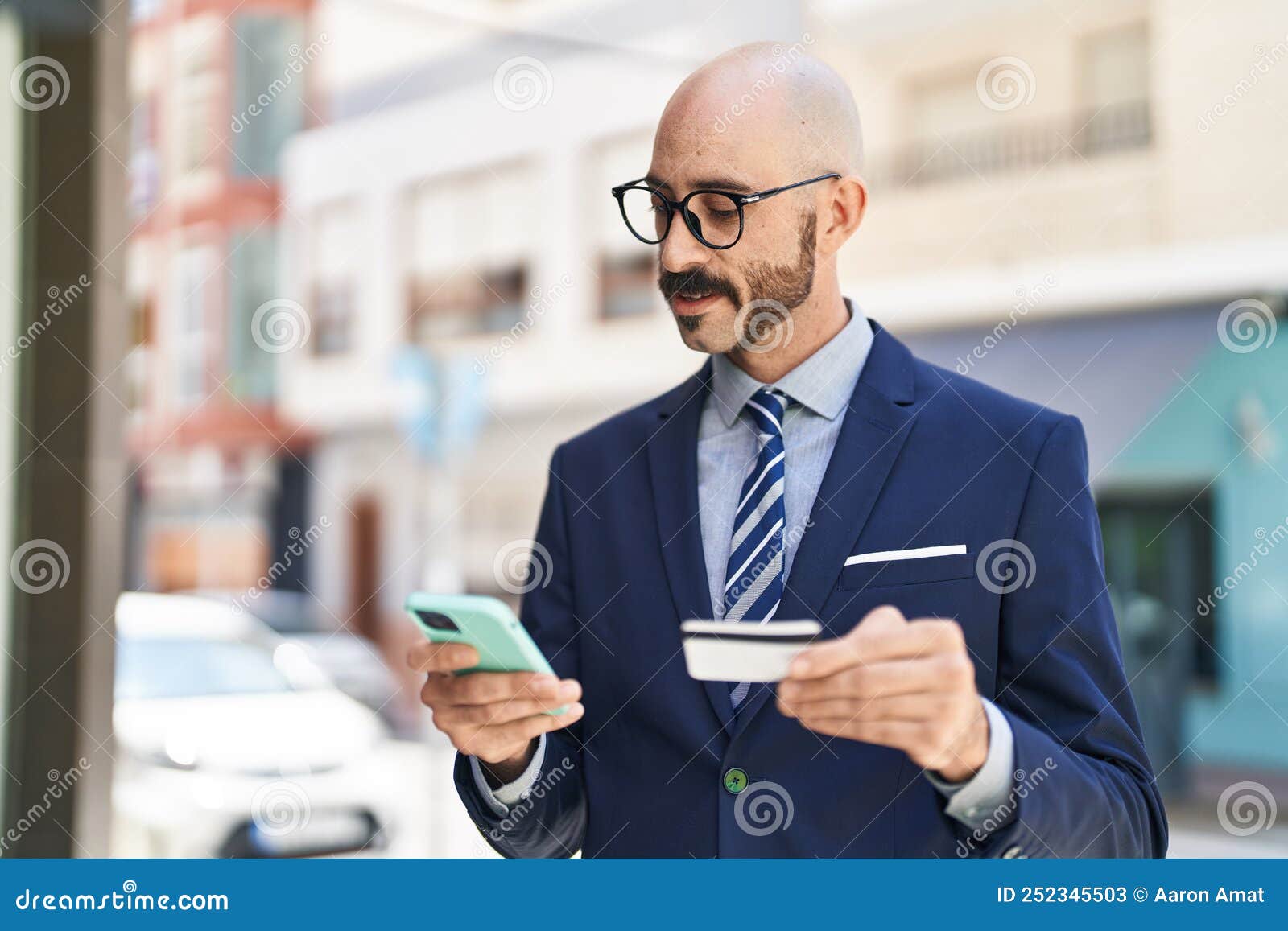 Young Hispanic Man Executive Using Smartphone and Credit Card at Street ...