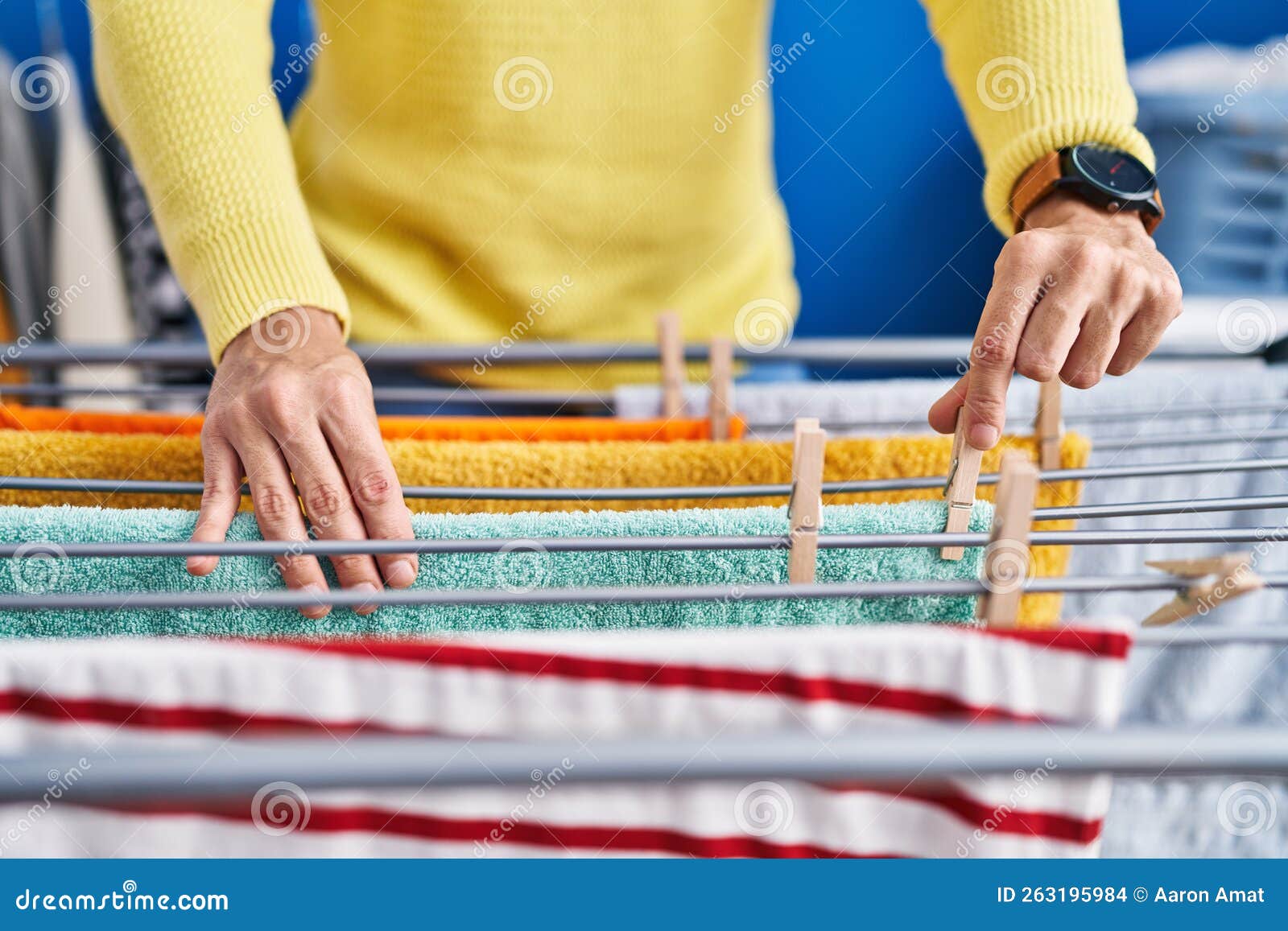 Young Hispanic Man Hanging Clothes on Clothesline at Laundry Room Stock ...