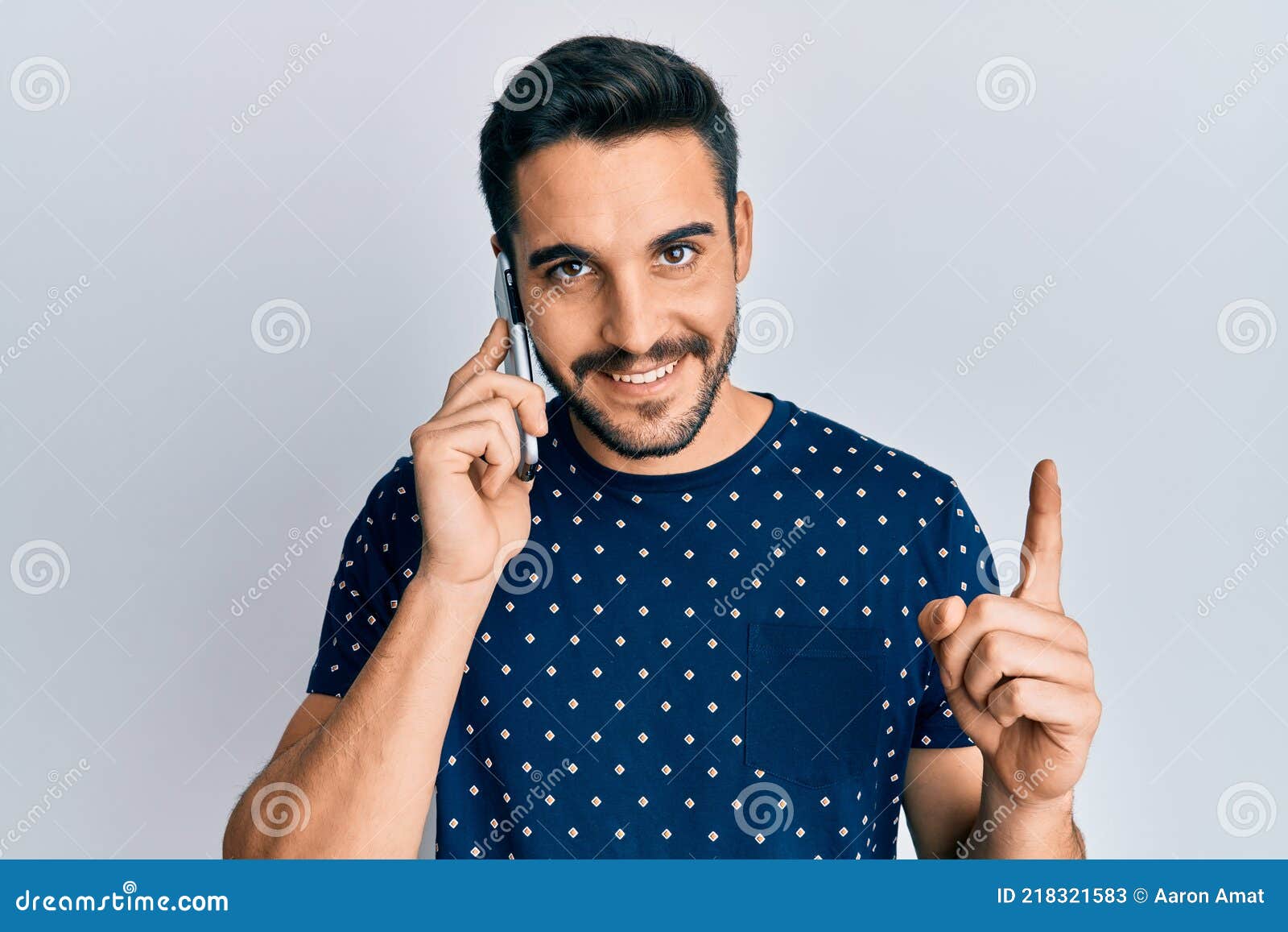 Young Hispanic Man Having Conversation Talking on the Smartphone ...