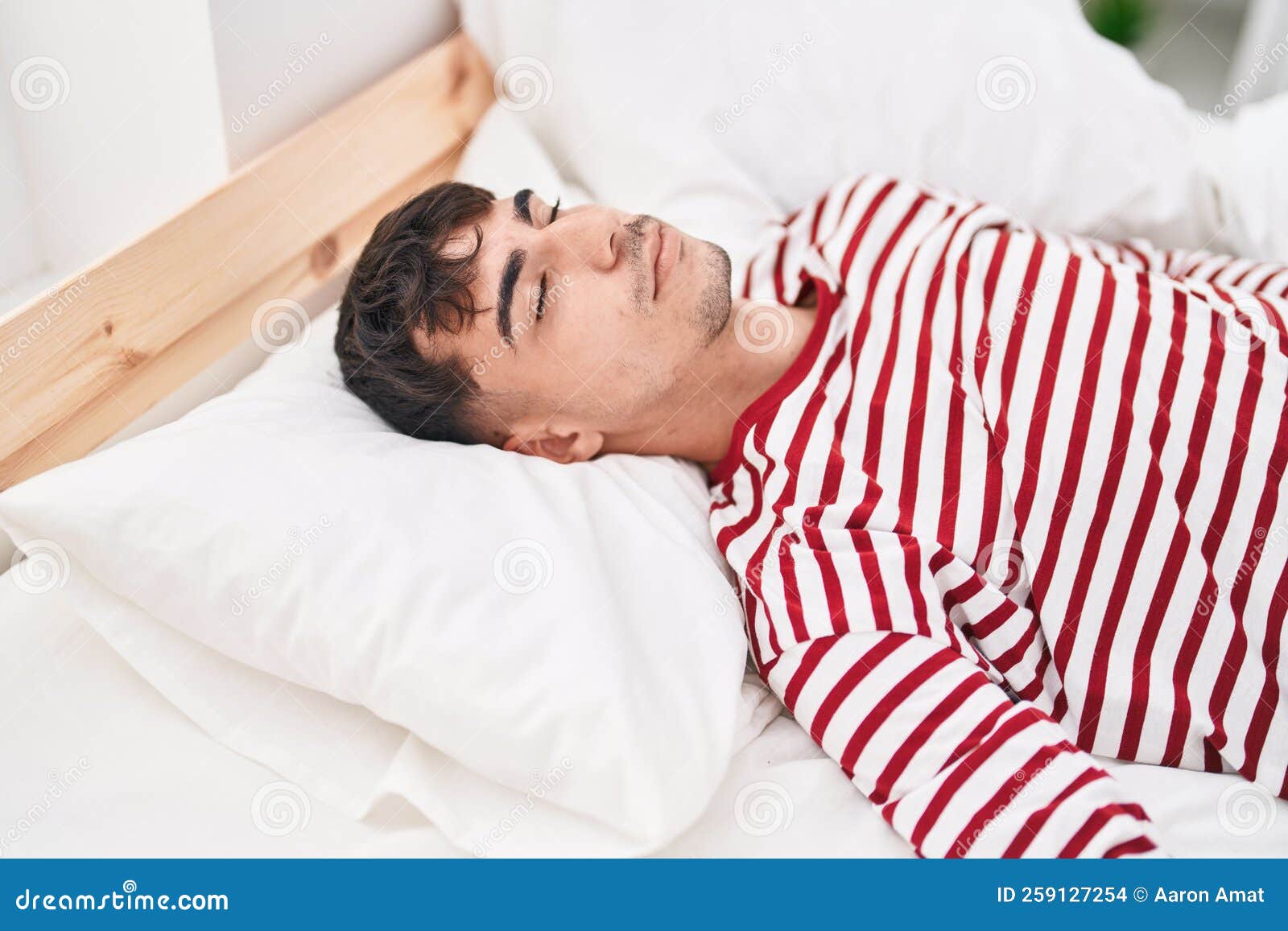 Young Hispanic Man Lying on Bed Sleeping at Bedroom Stock Photo - Image ...
