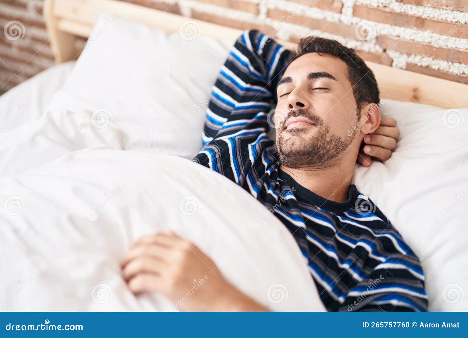 Young Hispanic Man Lying on Bed Sleeping at Bedroom Stock Photo - Image ...