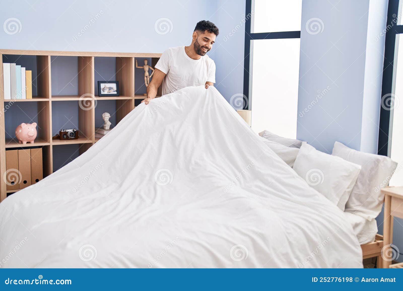 Young Hispanic Man Make Bed Standing at Bedroom Stock Photo - Image of ...