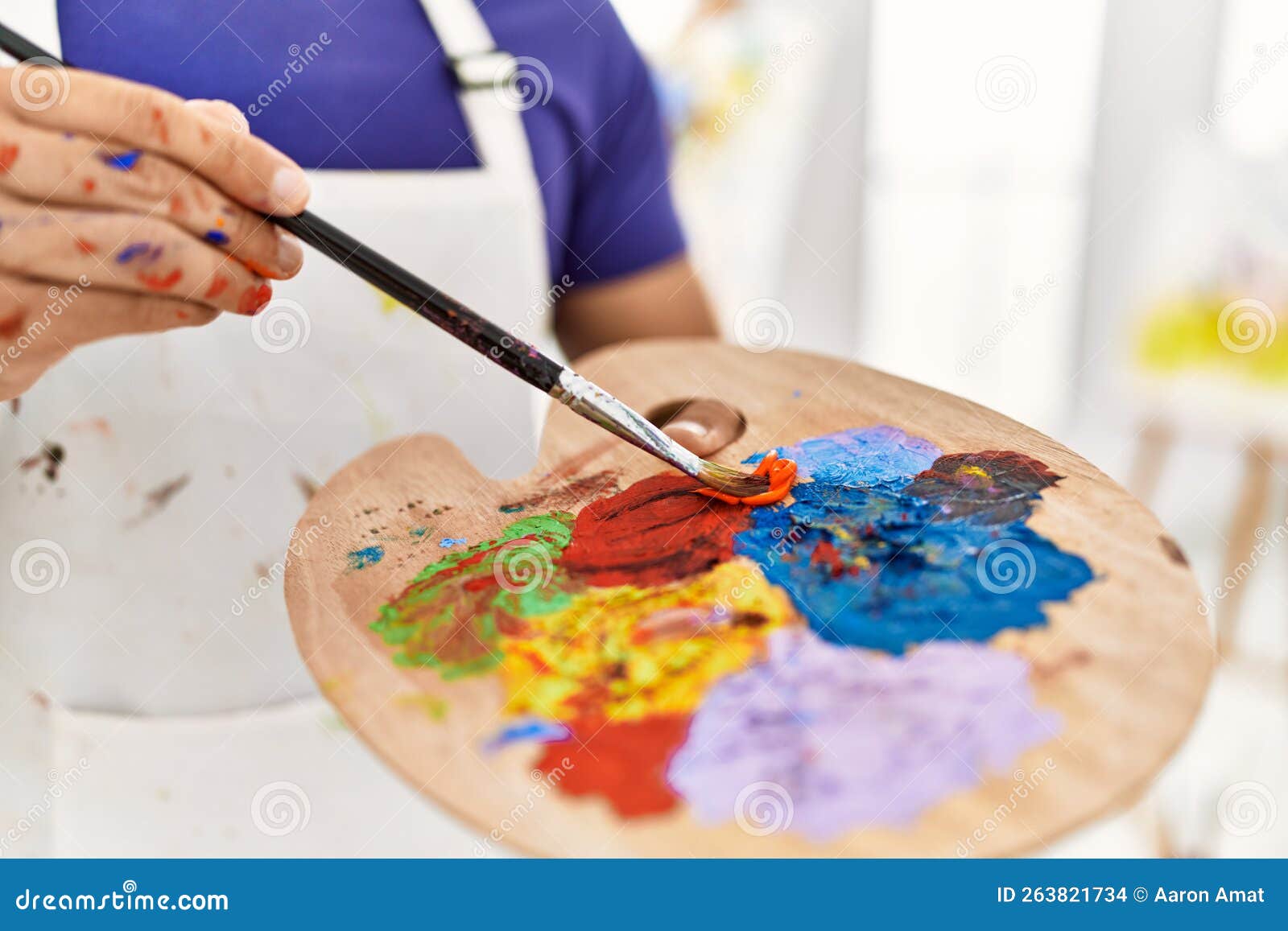 Young Hispanic Man Mixing Color on Palette at Art Studio Stock Photo ...