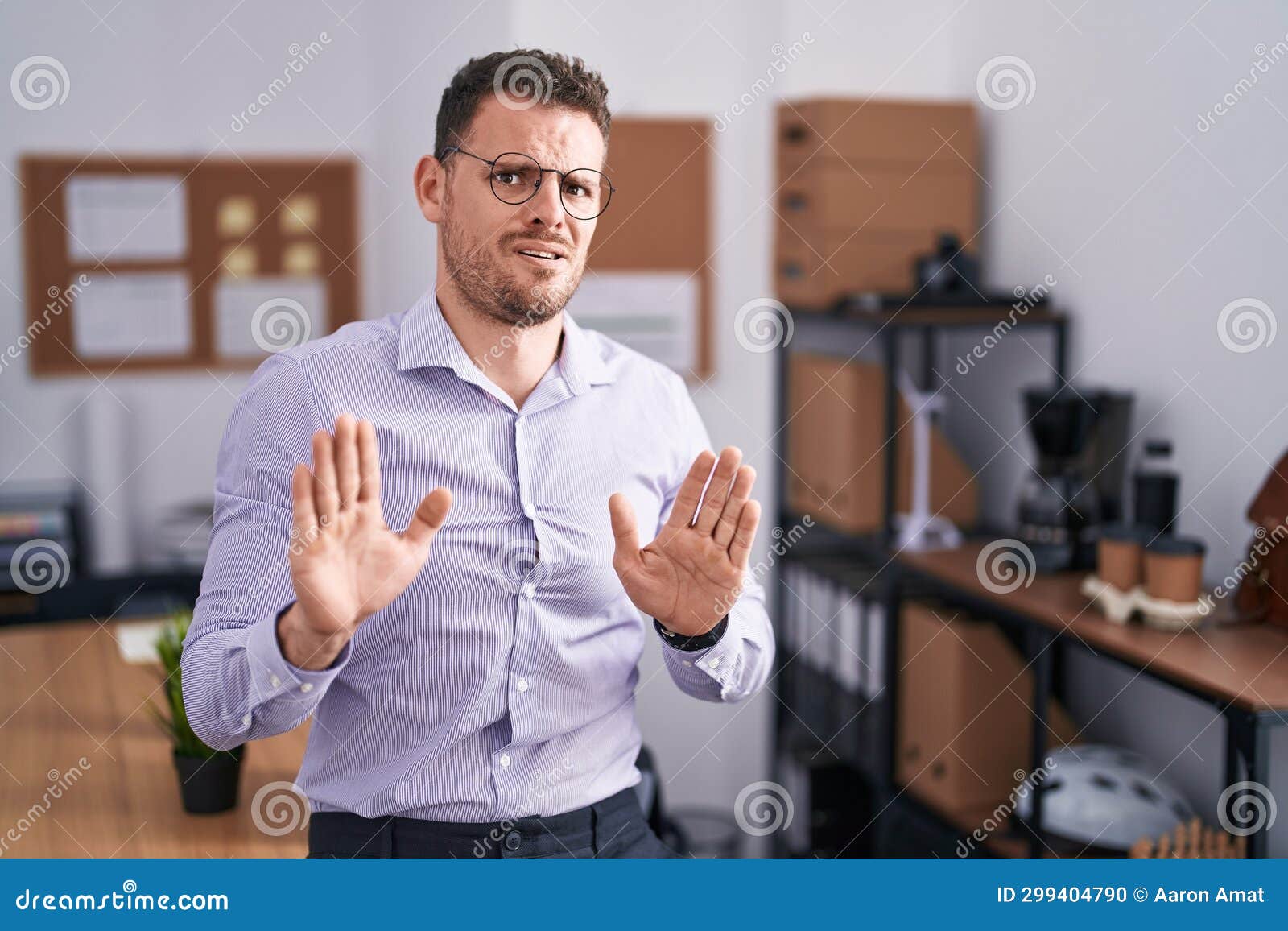 Young Hispanic Man at the Office Moving Away Hands Palms Showing ...