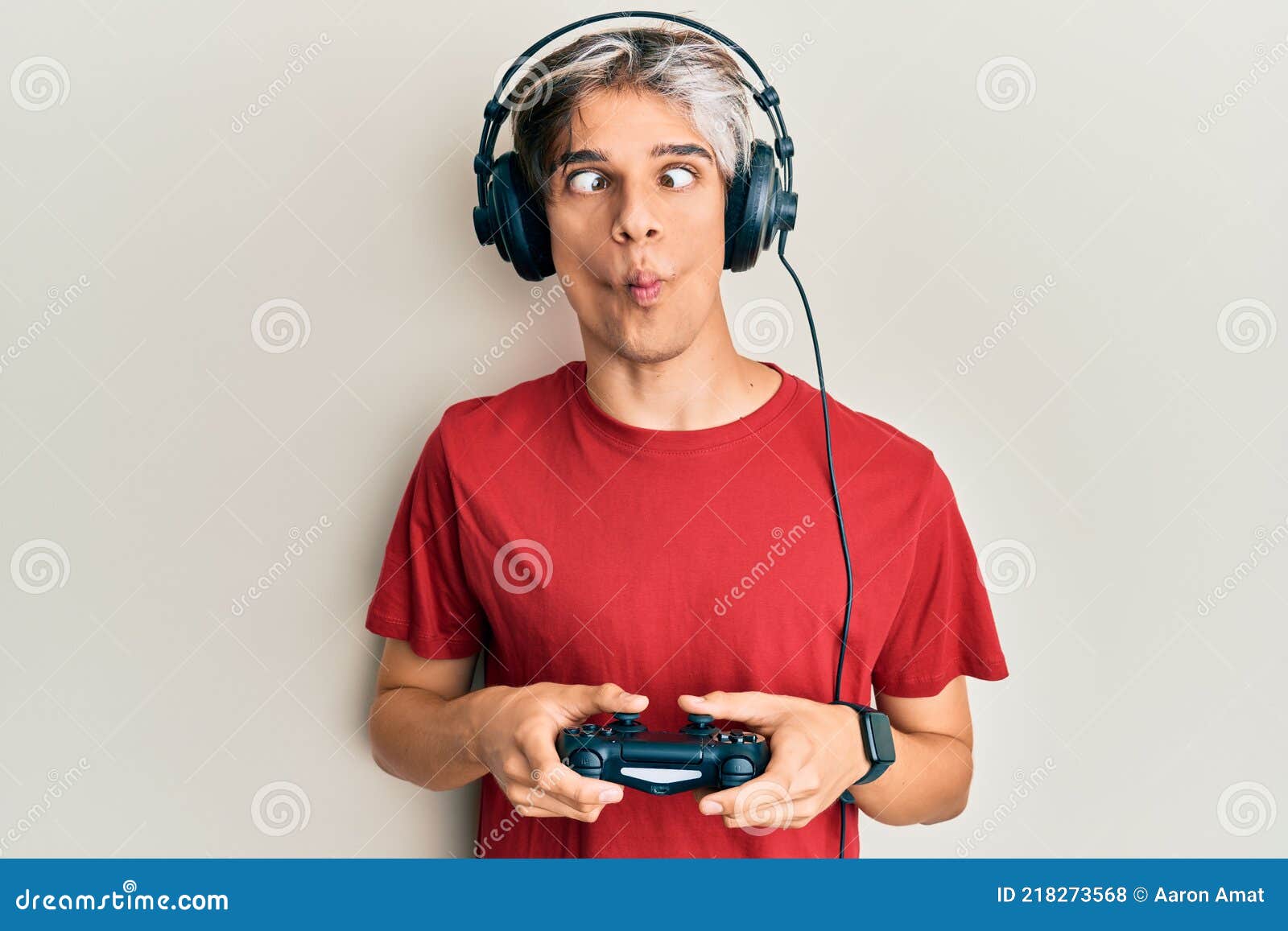 Young Hispanic Man Playing Video Game Holding Controller Making Fish ...