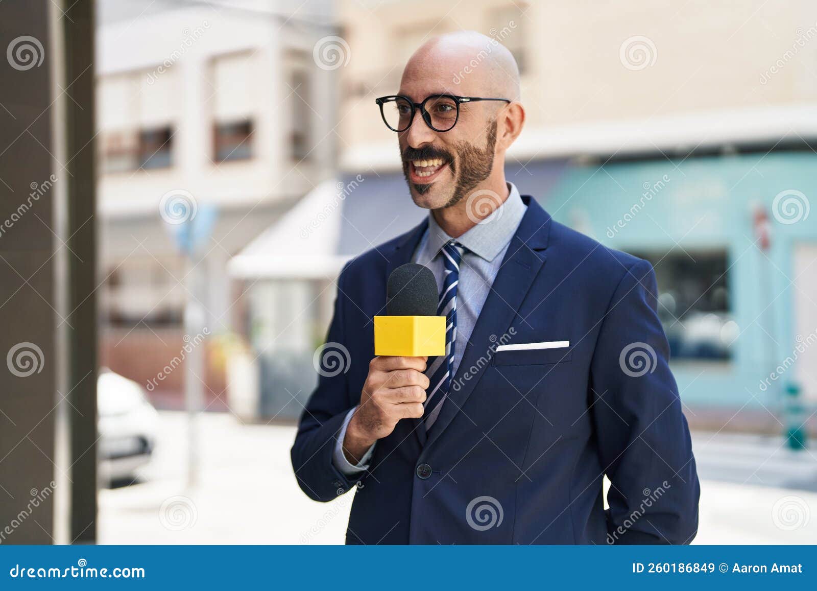 Young Hispanic Man Reporter Working Using Microphone at Street Stock ...