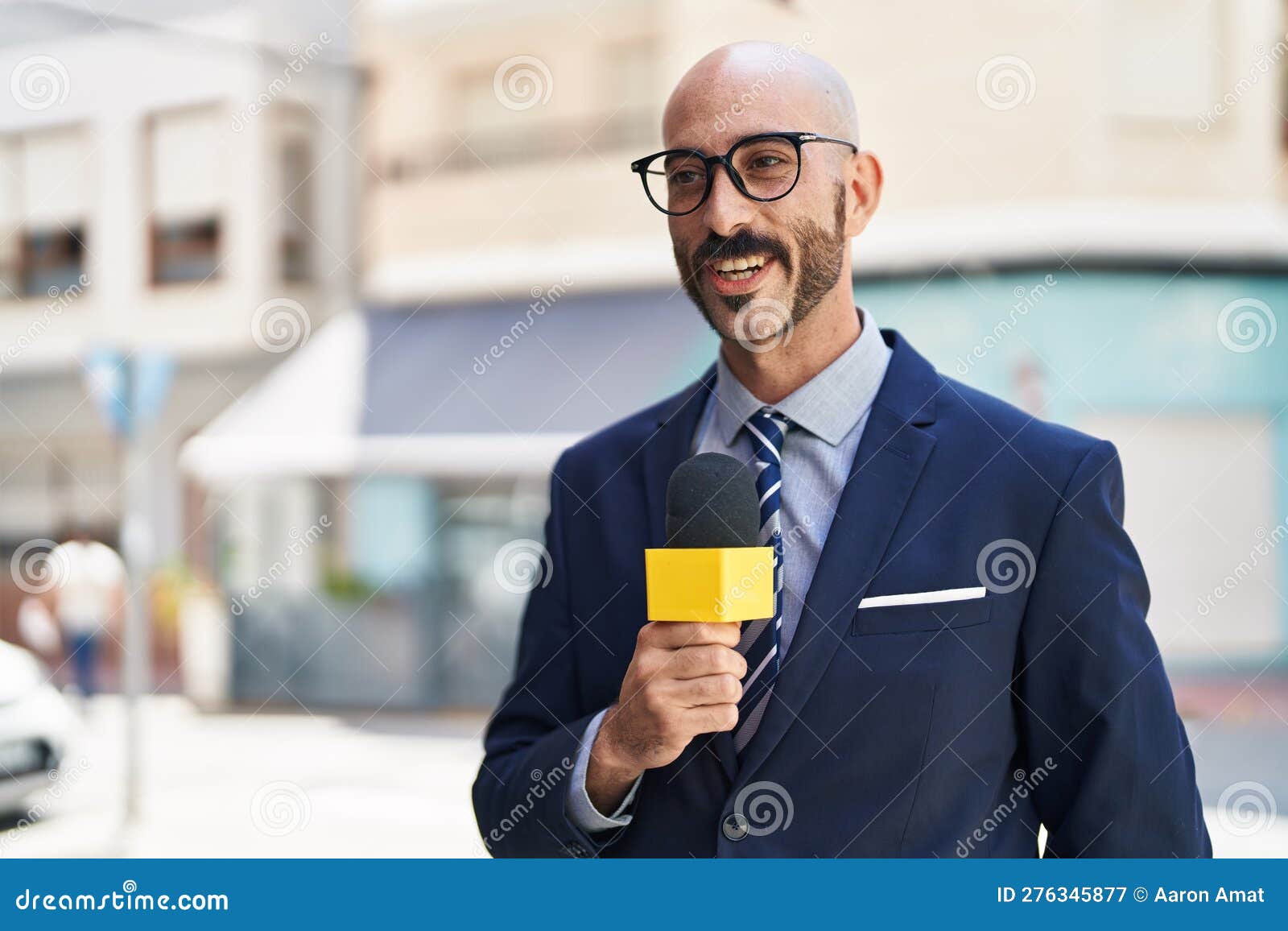 Young Hispanic Man Reporter Working Using Microphone at Street Stock ...