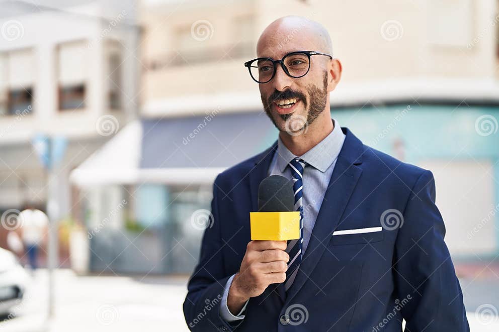 Young Hispanic Man Reporter Working Using Microphone at Street Stock ...