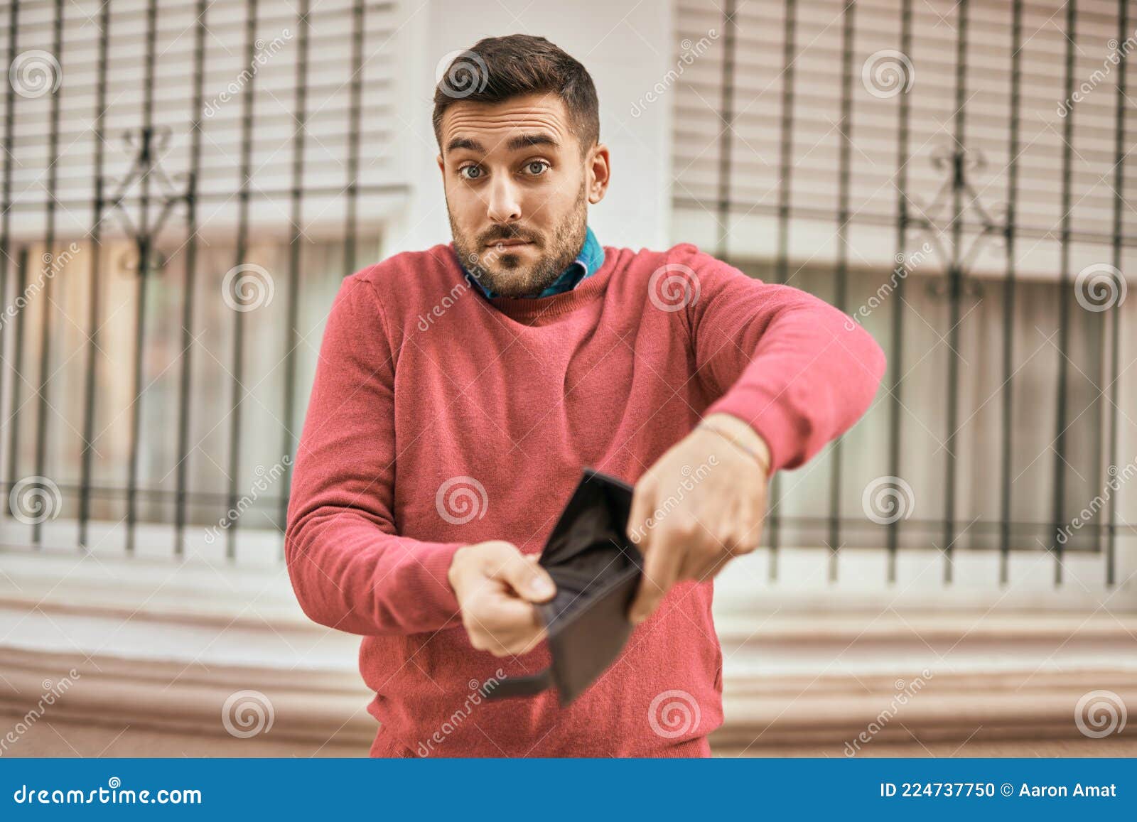 Young Hispanic Man with Sad Expression Showing Empty Wallet at the City ...