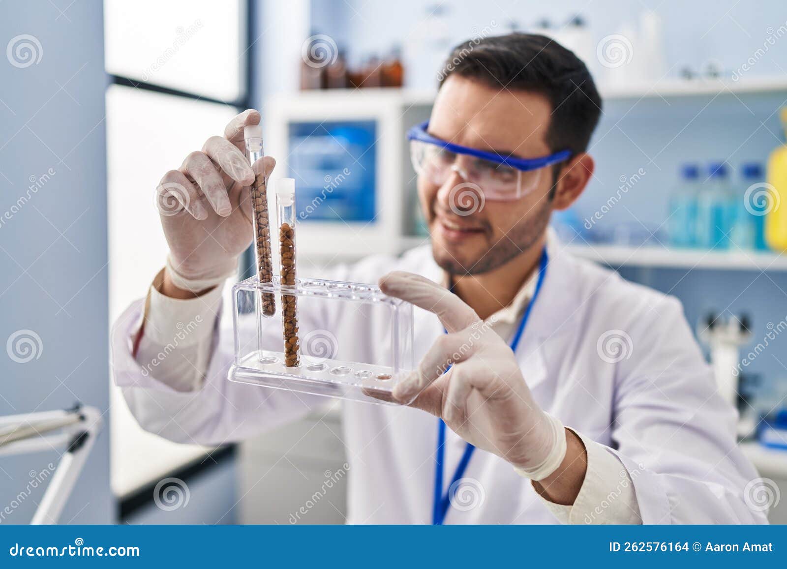 Young Hispanic Man Scientist Holding Test Tubes at Laboratory Stock ...